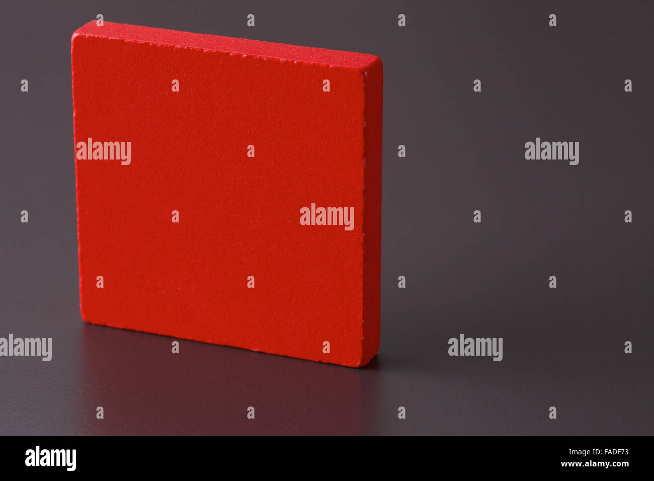 a red square wooden block Stock Photo - Alamy