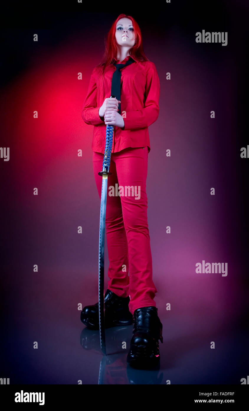Girl in a red suit with a Japanese sword. very sad Stock Photo - Alamy