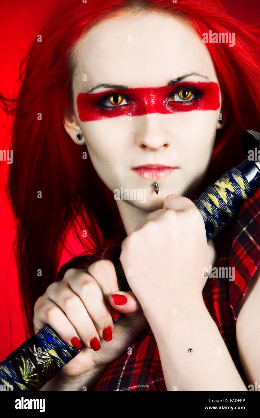 Girl with red hair and a Japanese sword Stock Photo - Alamy