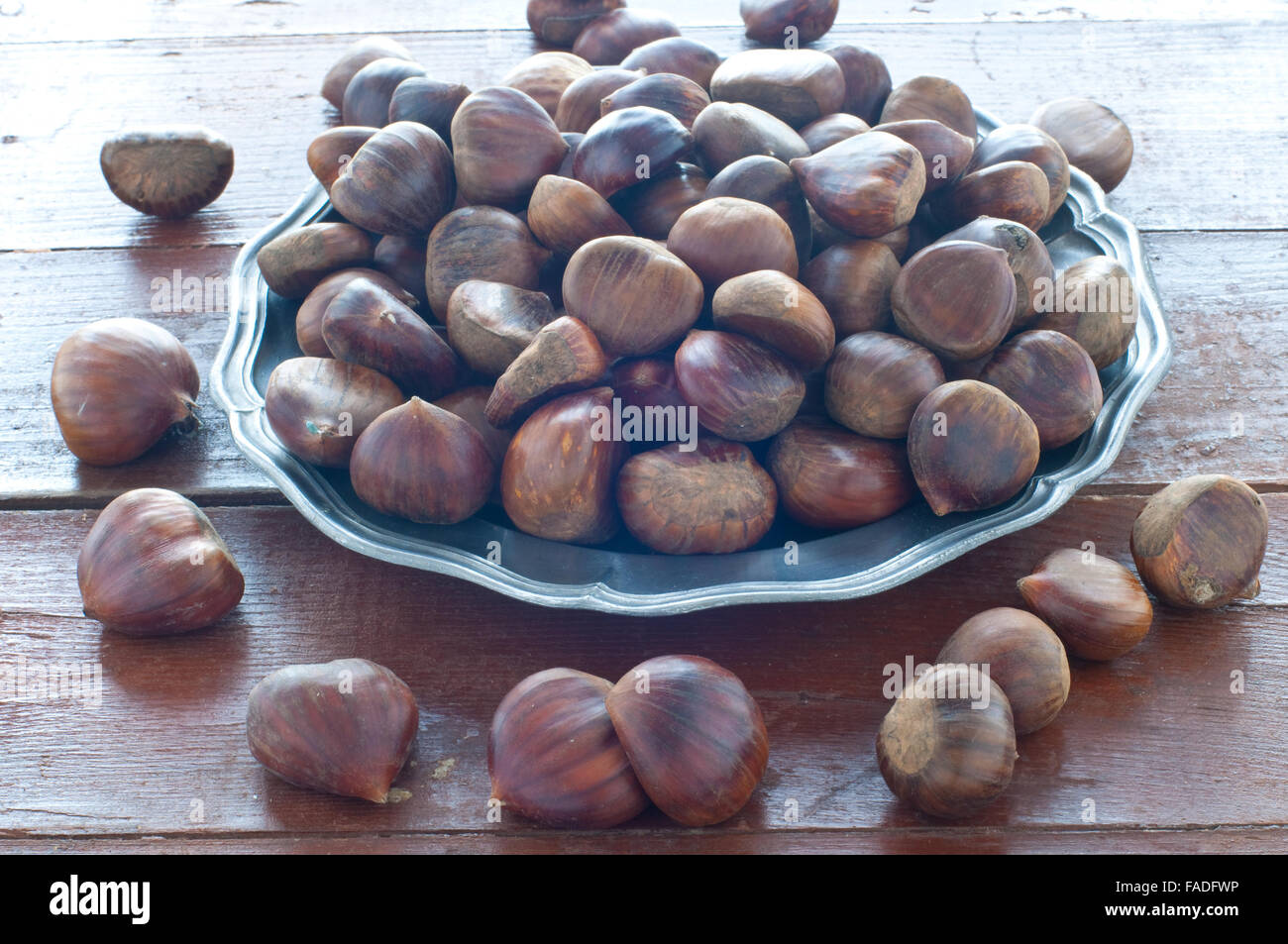 Group of raw chestnuts ready to be cooked,italy Stock Photo - Alamy