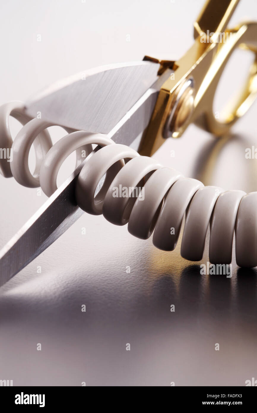 Phone cord being cut by scissors Stock Photo - Alamy