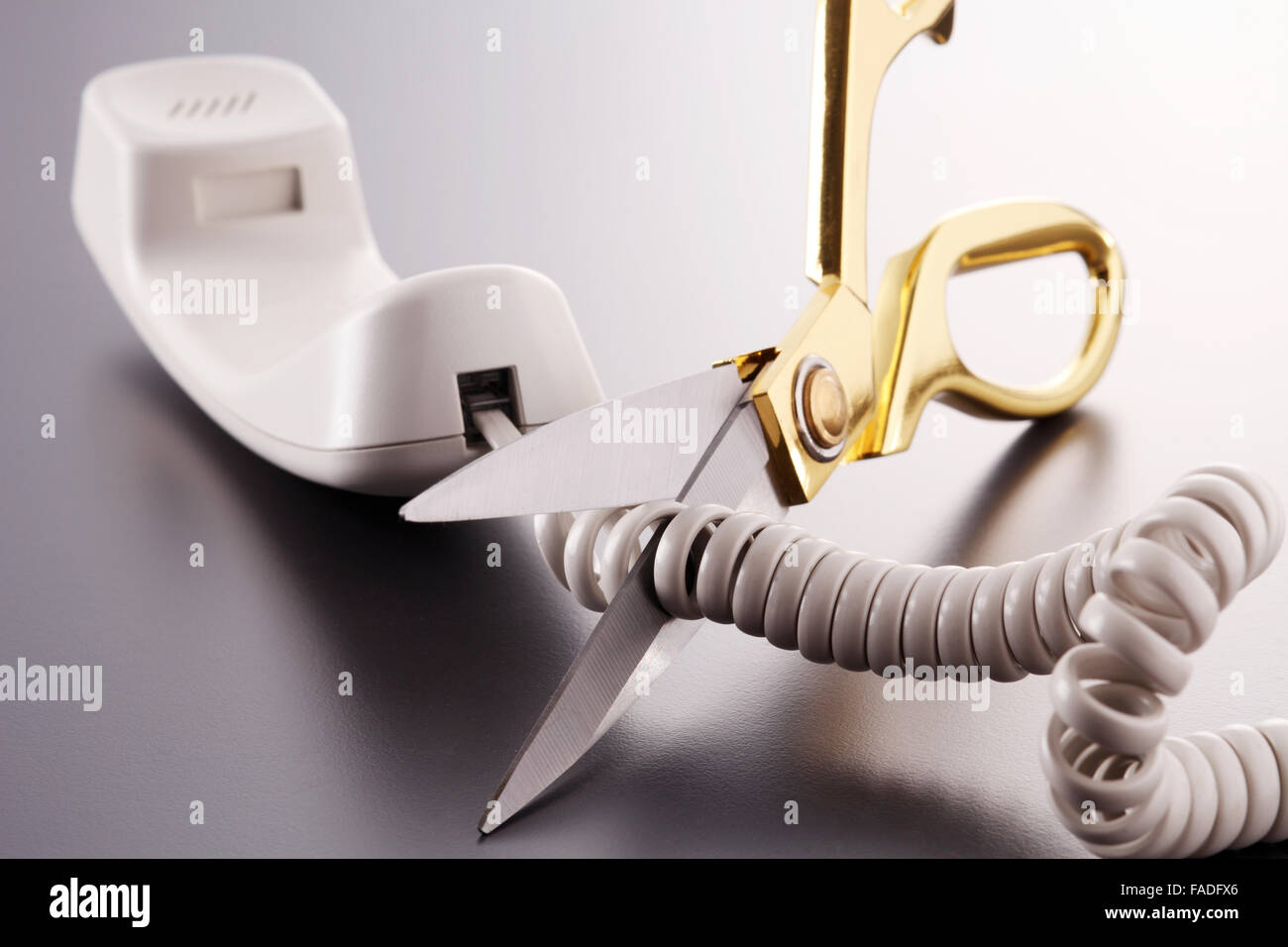 Phone cord being cut by scissors Stock Photo - Alamy