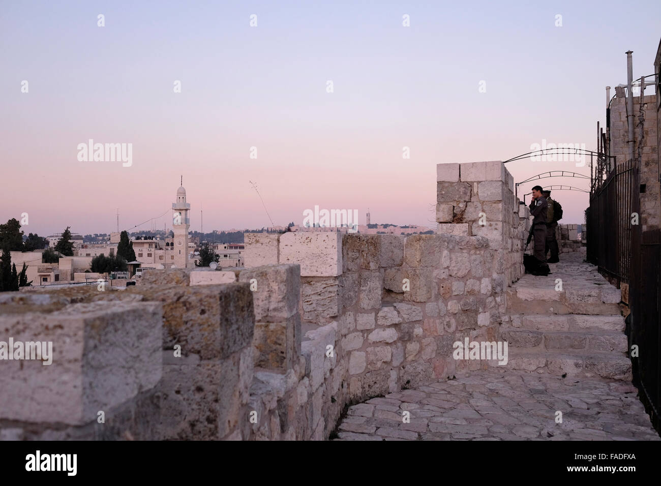 Israeli border policemen stand guard in the upper sentry path of the ...