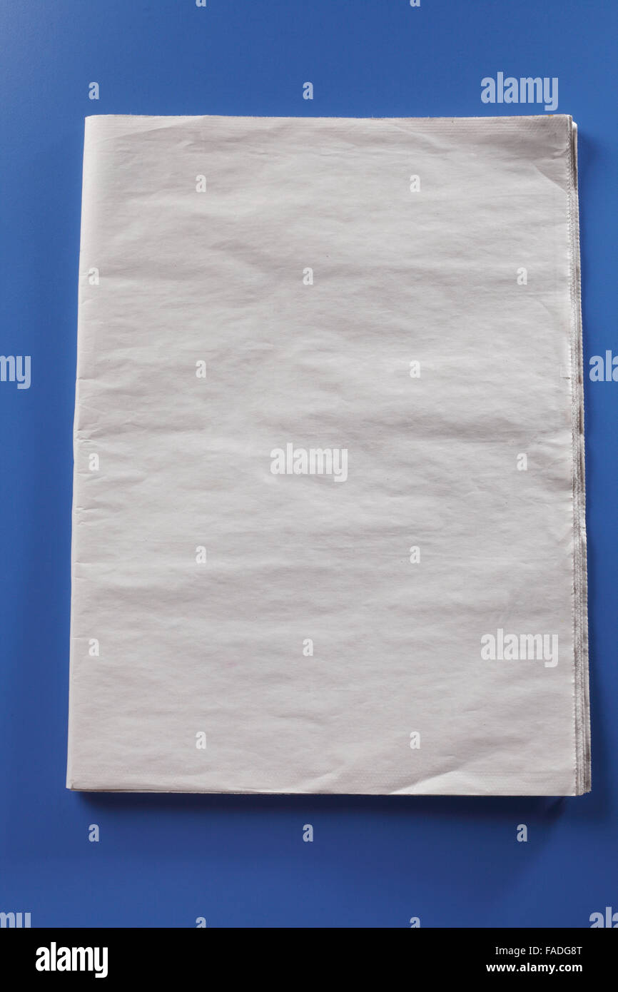 Blank nespaper on the blue background Stock Photo - Alamy
