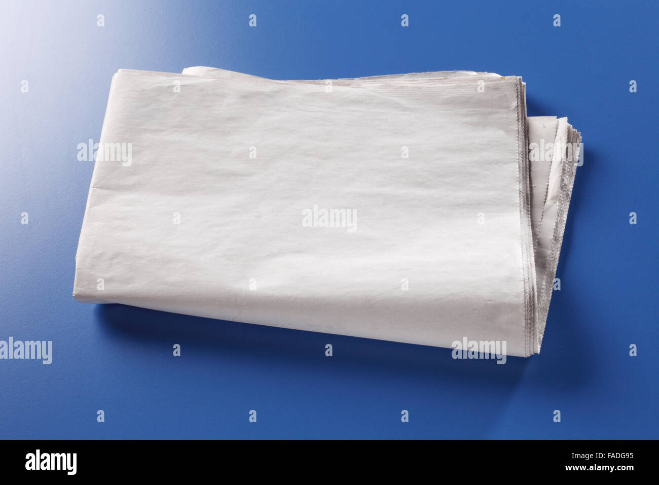 Blank nespaper on the blue background Stock Photo - Alamy