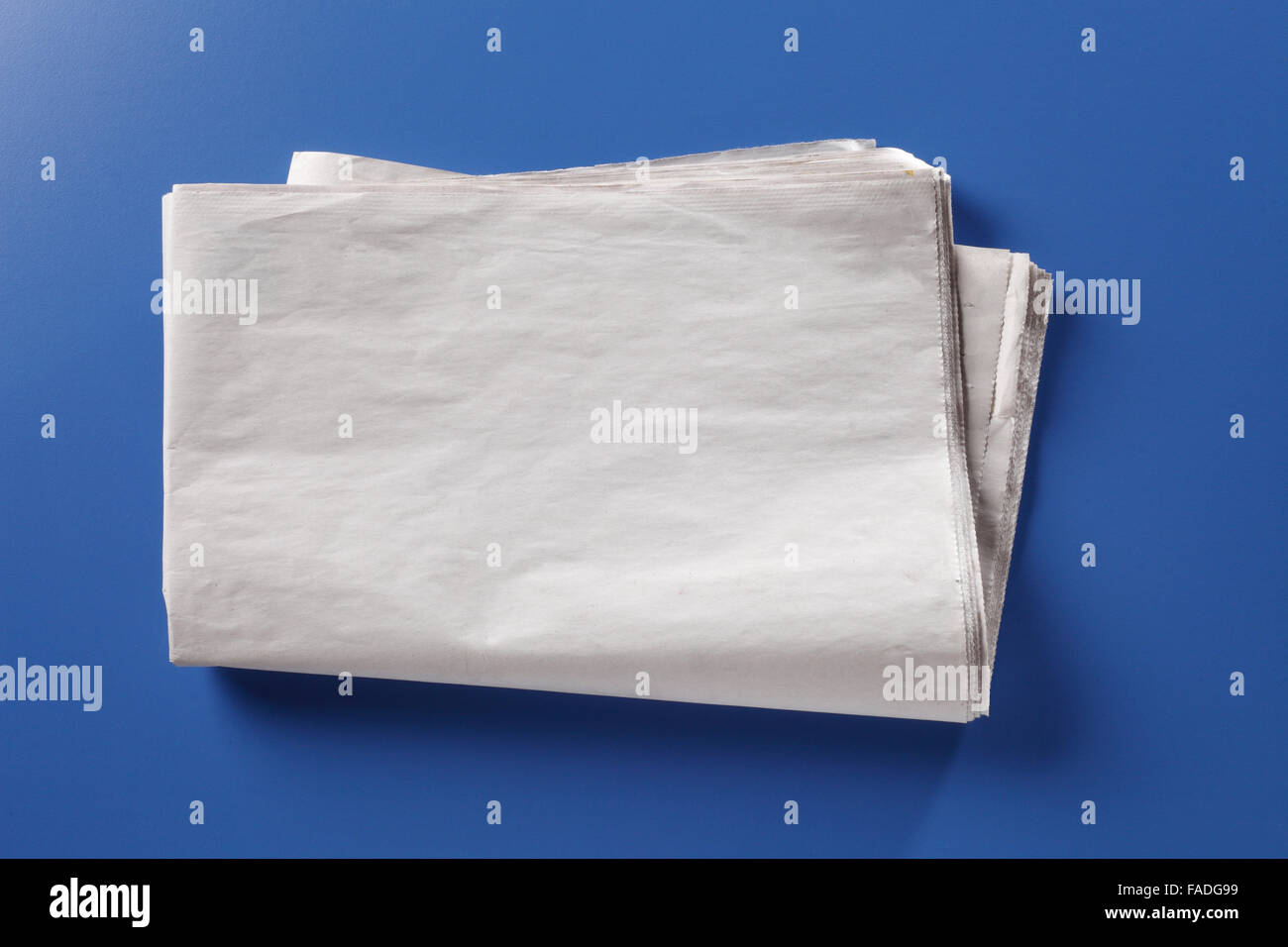 Blank nespaper on the blue background Stock Photo - Alamy