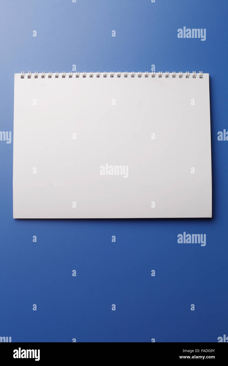 spiral note on the blue background Stock Photo - Alamy