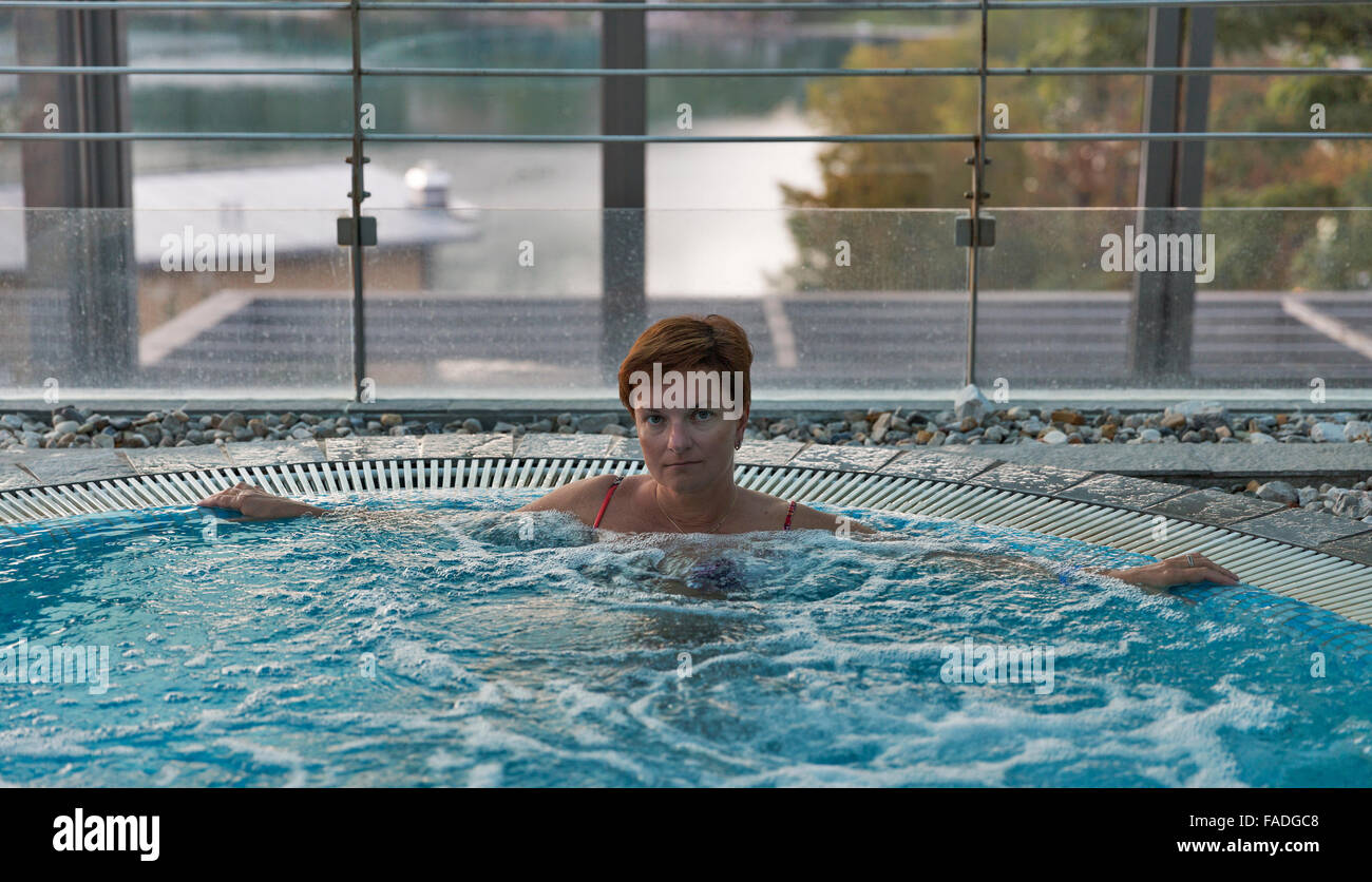 Middle aged Caucasian woman relaxing in jacuzzi with big window Stock ...