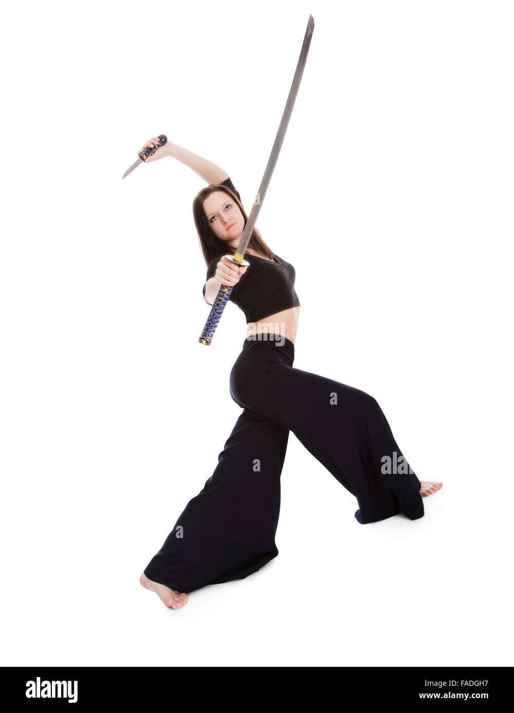 Beautiful woman in an aggressive posture with a sword on a white ...