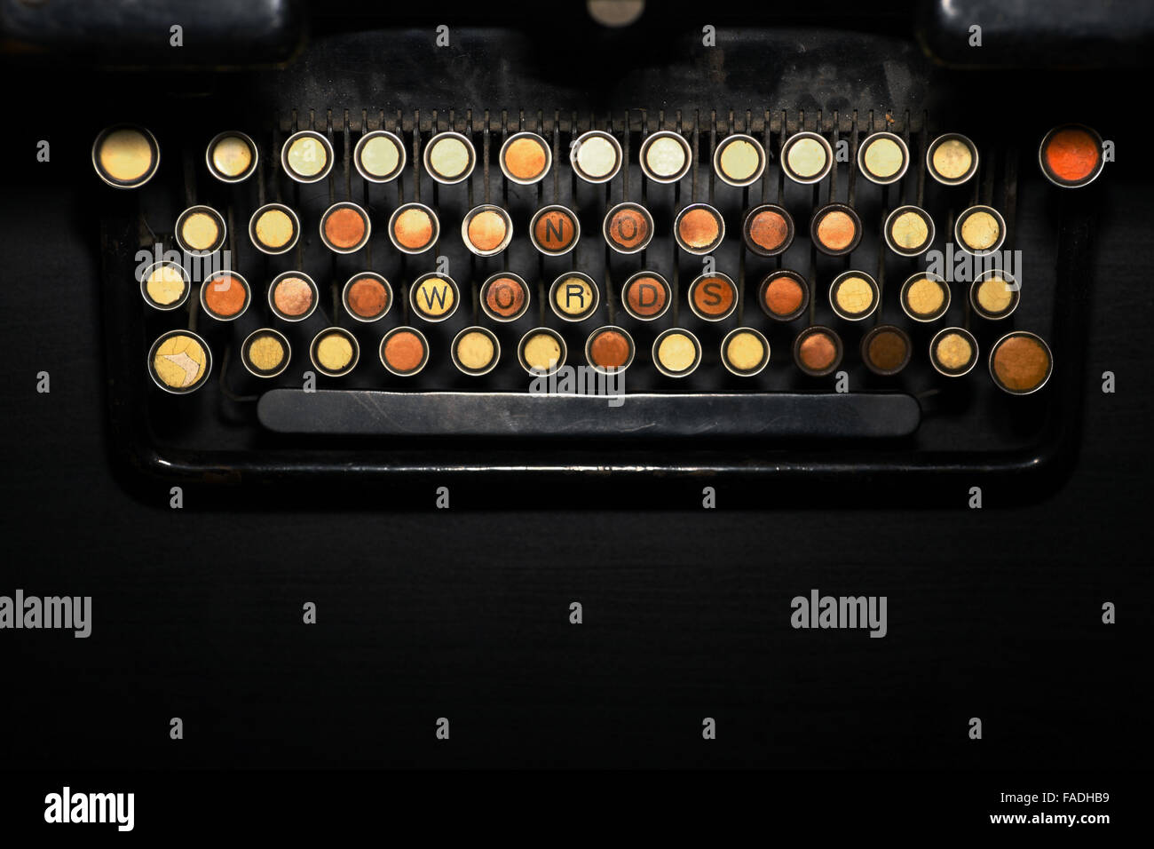 Color close up of a typewriter keyboard, having the words 'NO WORDS ...