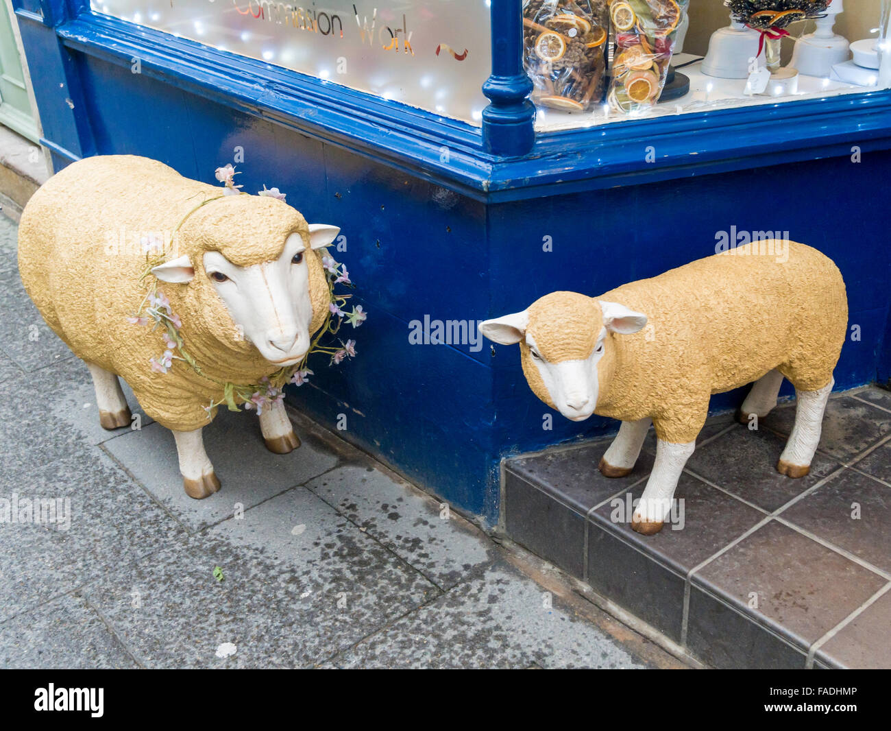 An ornamental near life-sized sheep and lamb outside a house interior ...