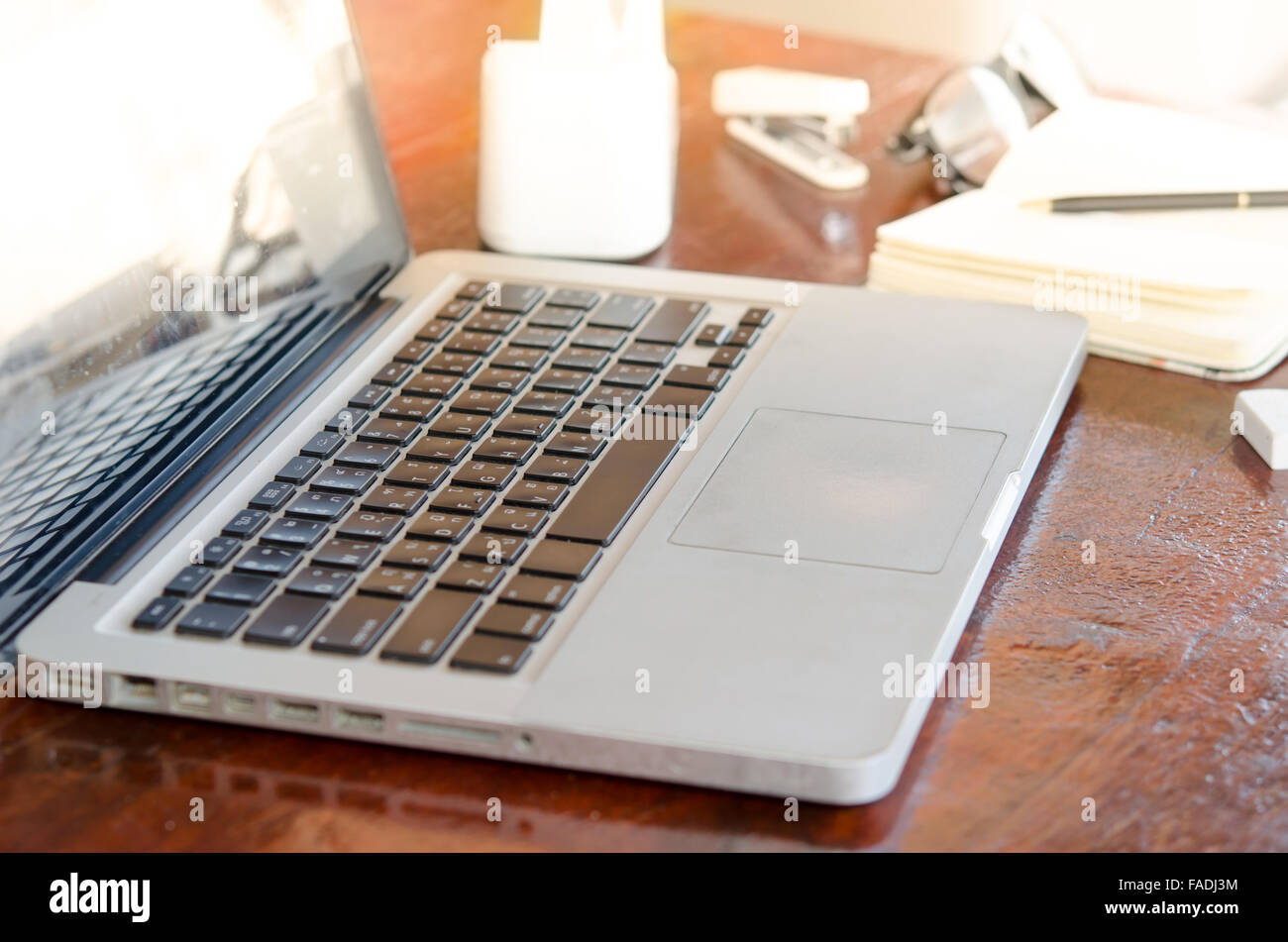 Workplace with open laptop on modern wooden desk Stock Photo - Alamy