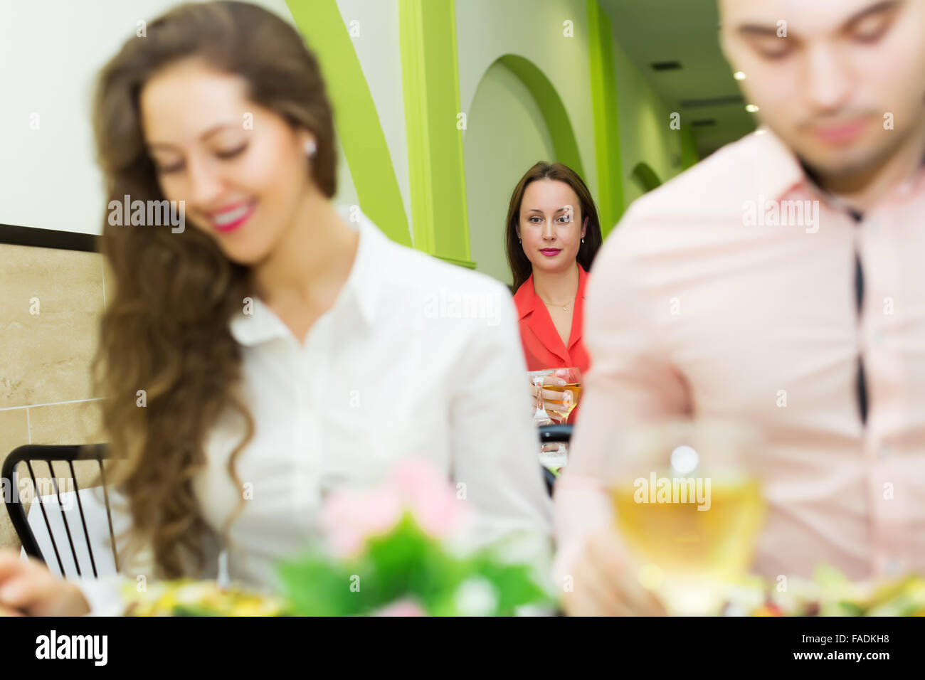 people having dinner at the restaurant. Focus on alone woman Stock ...