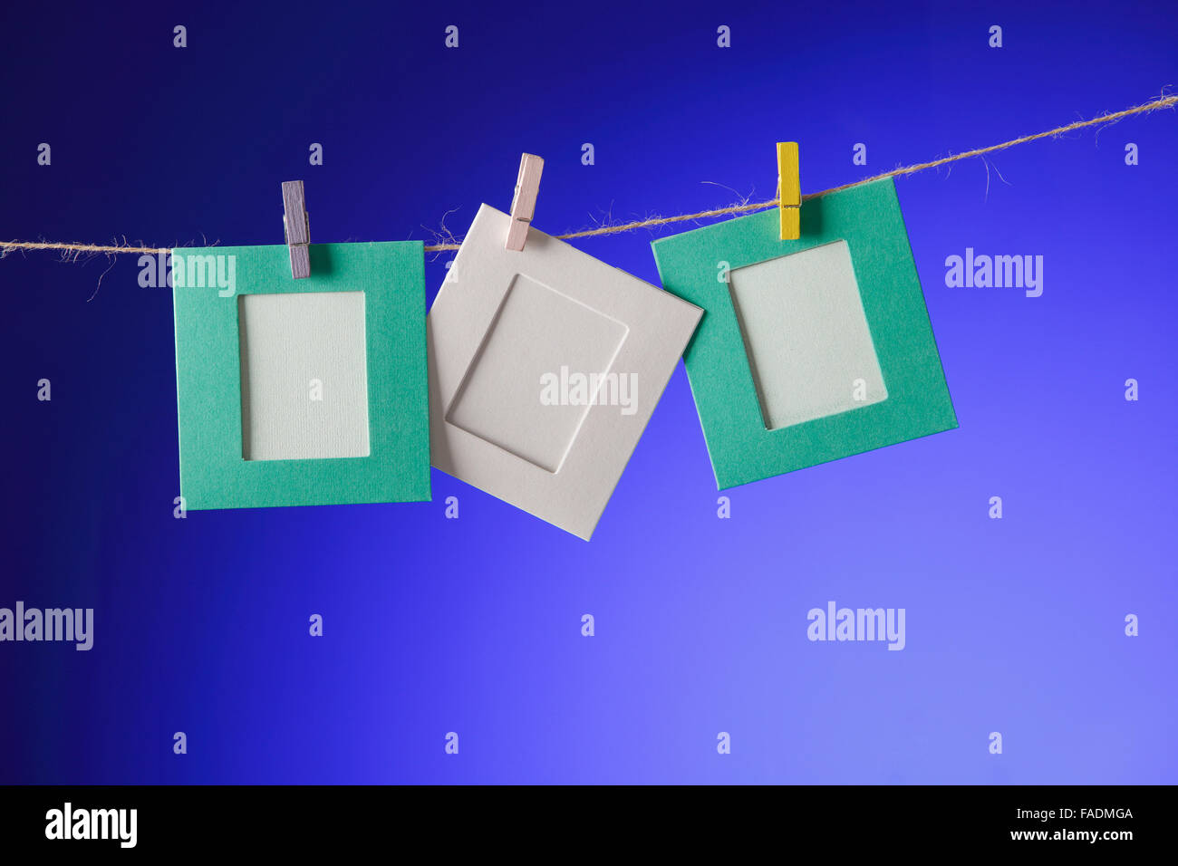 Two Photo frames on the clothesline horizontal Stock Photo - Alamy