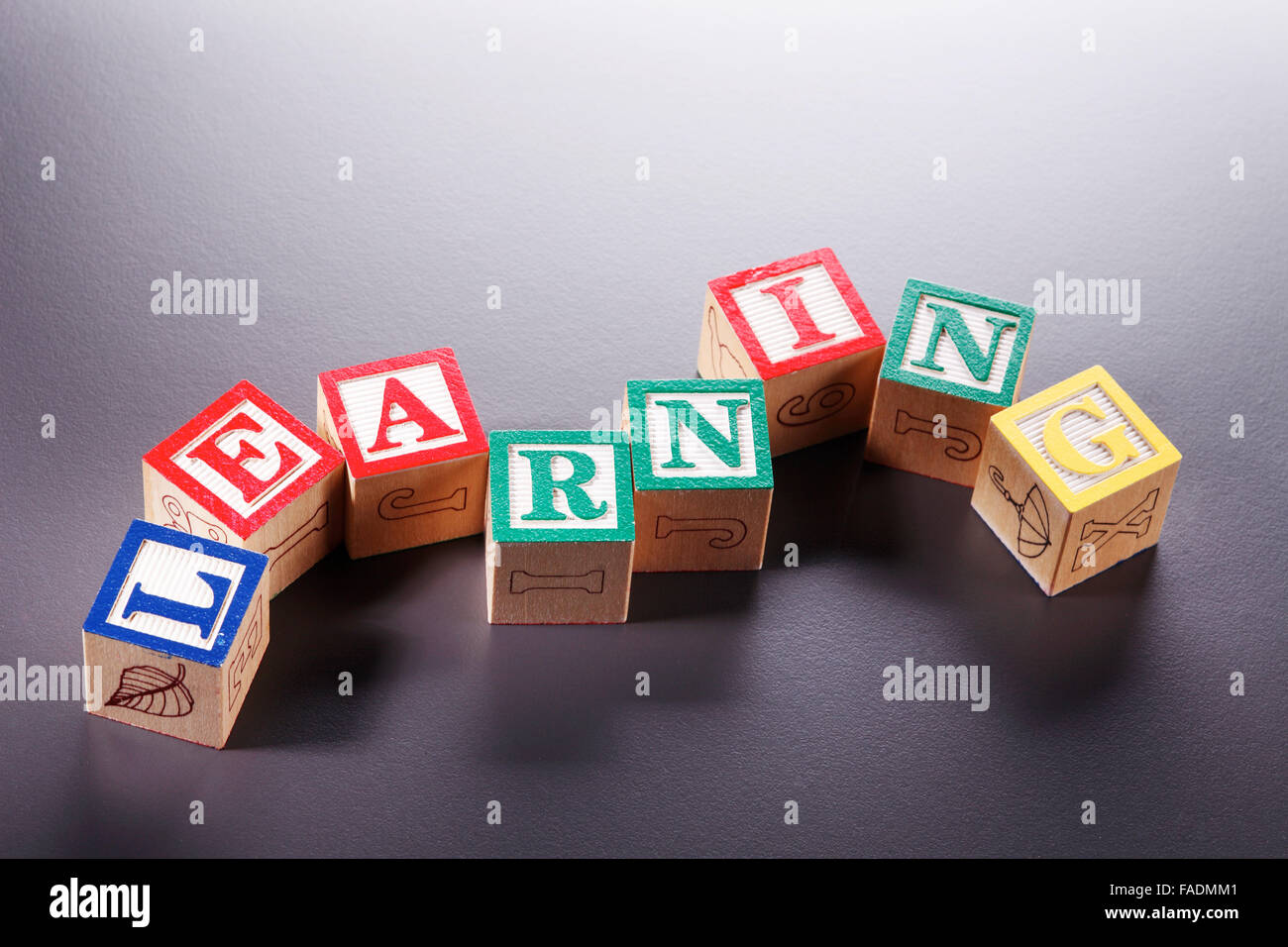 The word 'Learning' stacked by alphabet block Stock Photo - Alamy