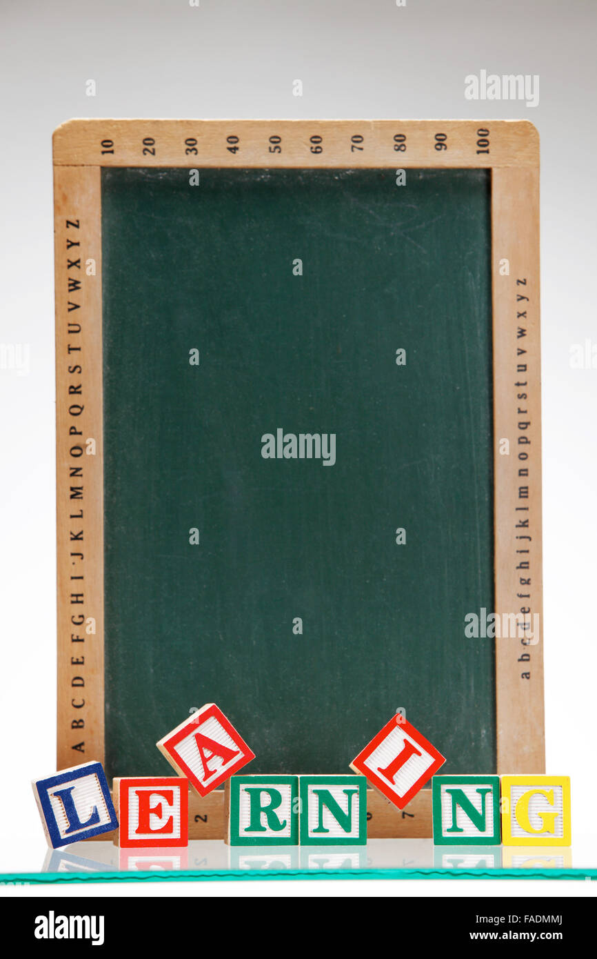close up of the alphabet blocks in front of the black board Stock Photo ...