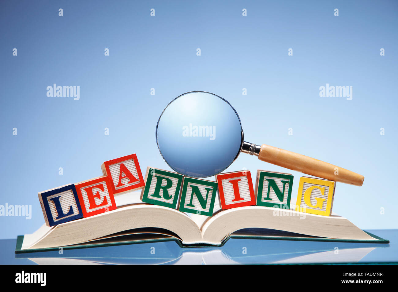 The word 'Learning' stacked by alphabet block Stock Photo - Alamy