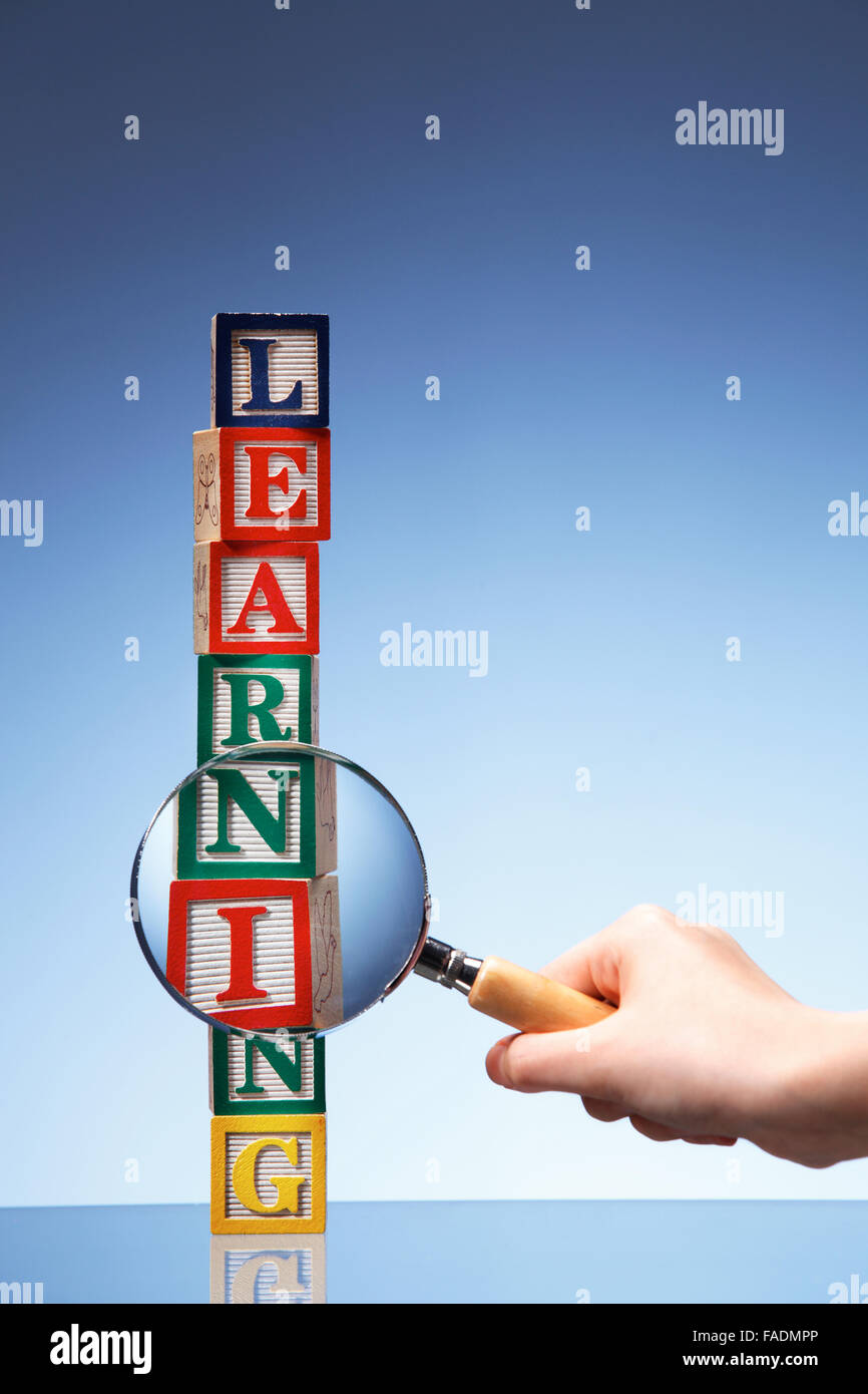 The word 'Learning' stacked by alphabet block Stock Photo - Alamy