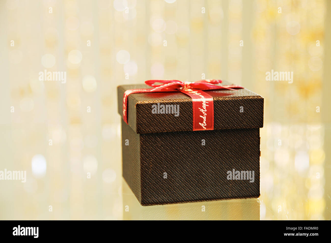 Wrapped gift with red ribbon Stock Photo - Alamy