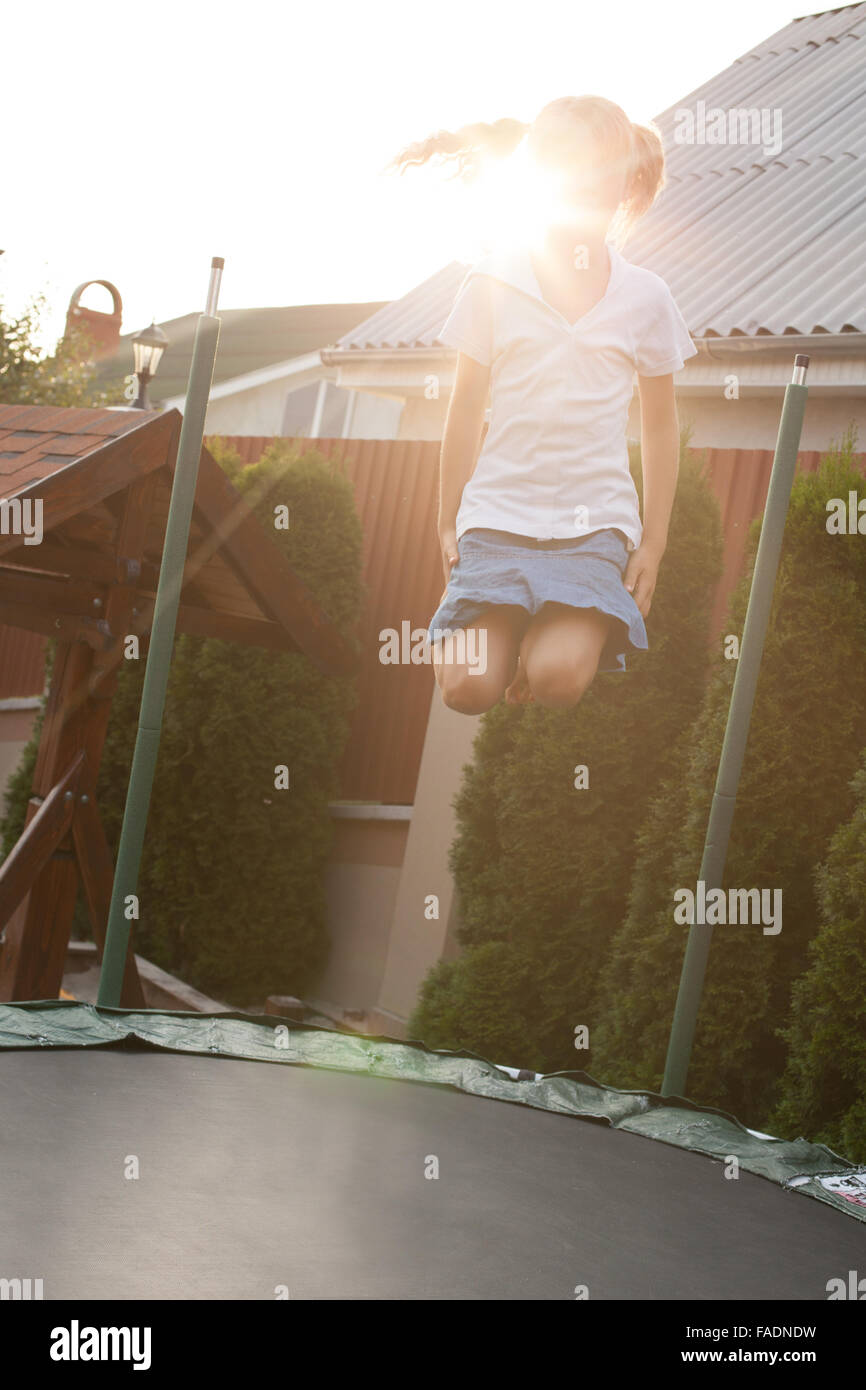 Girl is jumping on batut Stock Photo - Alamy