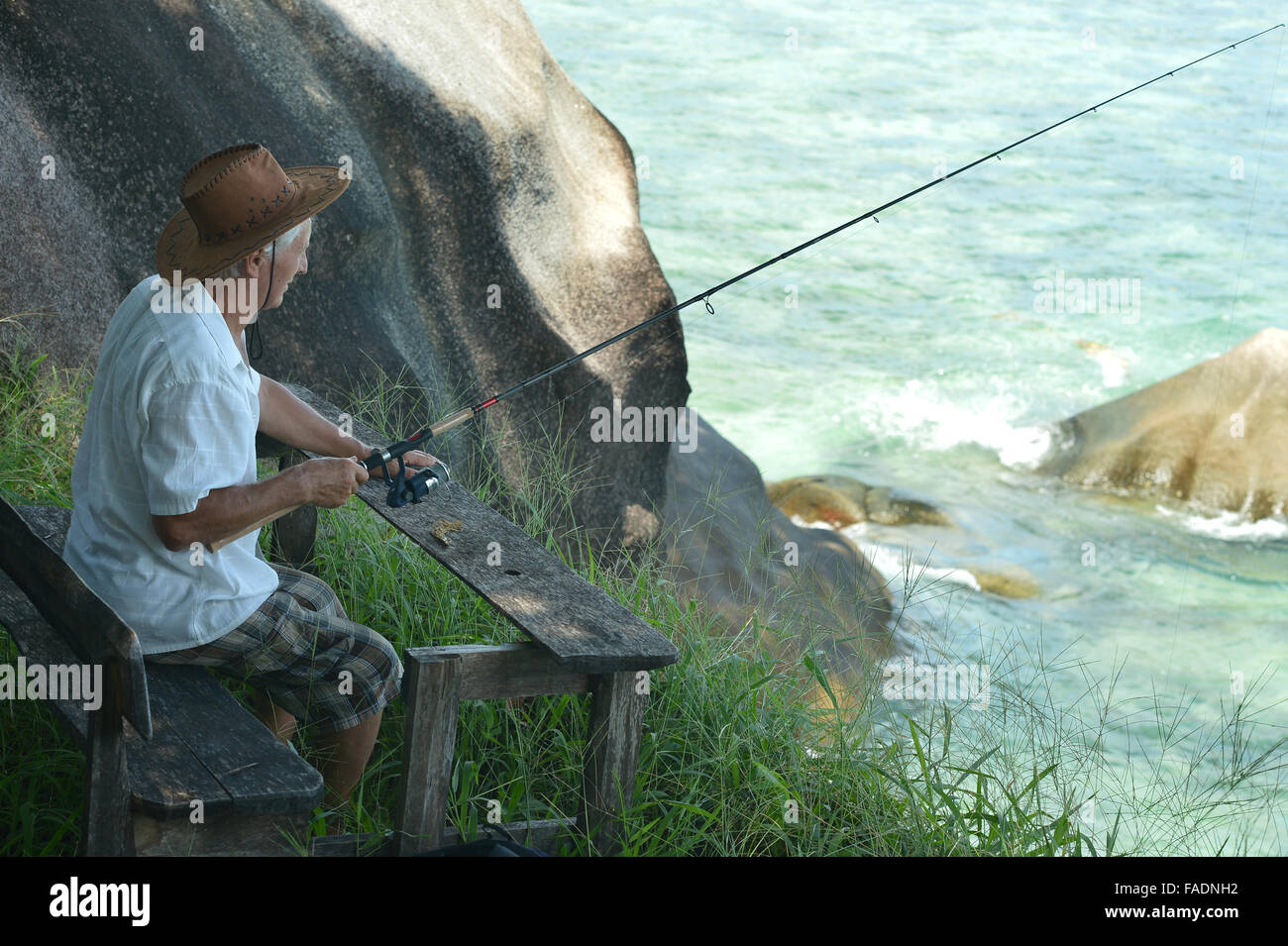 elderly man fishing in the sea Stock Photo - Alamy