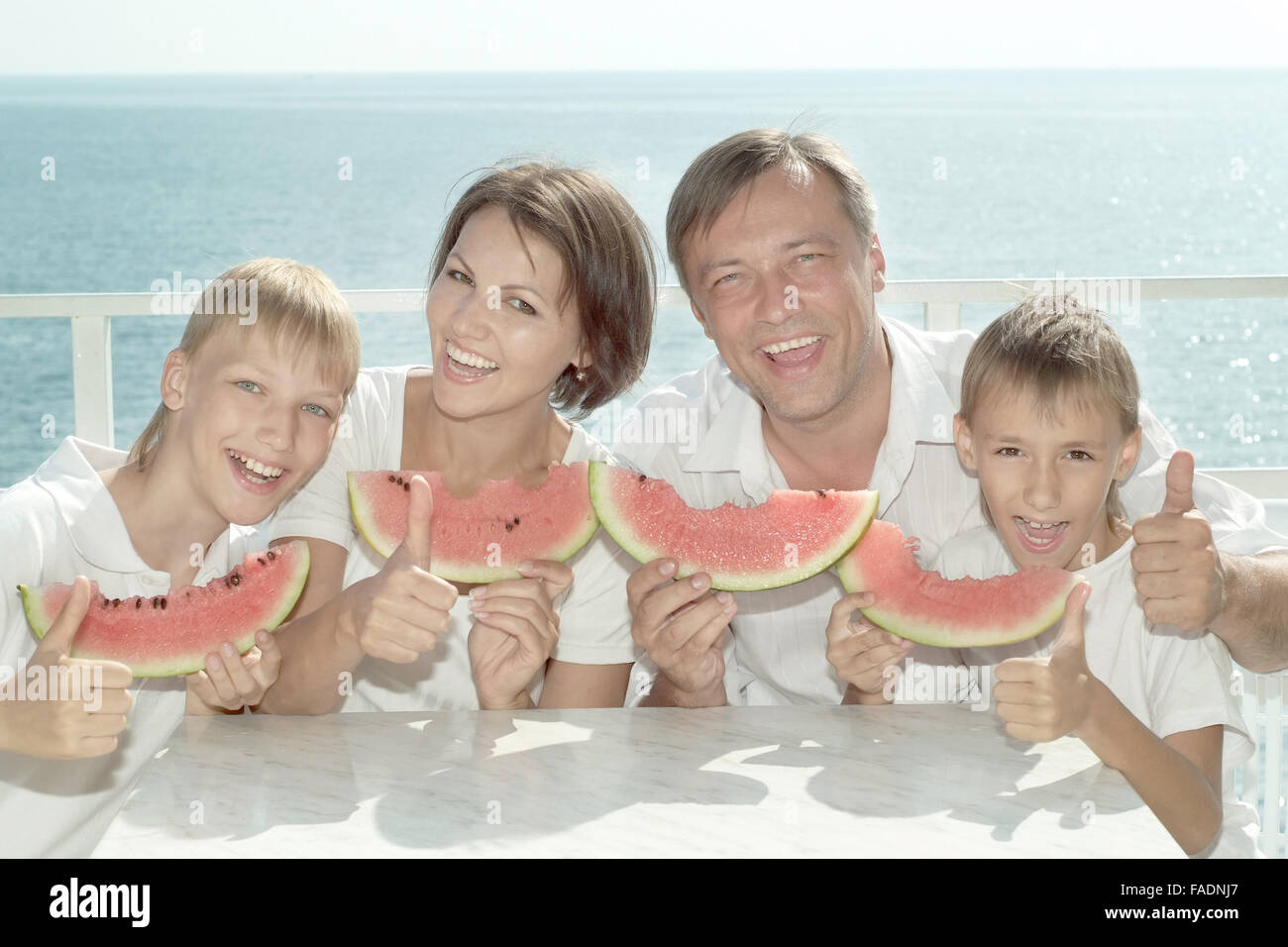 family eating watermelon Stock Photo - Alamy