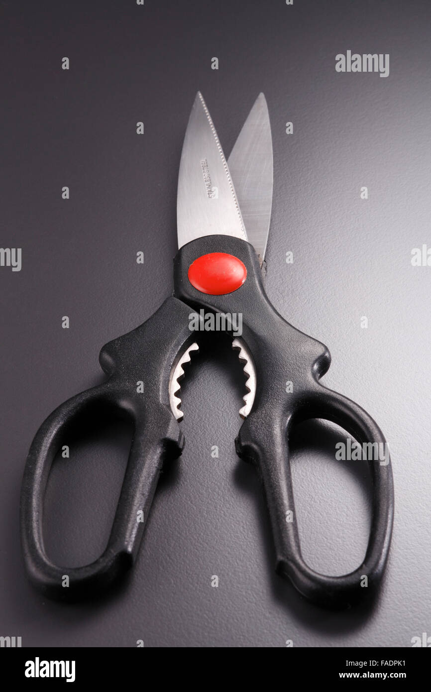 Open steel scissors with black plastic handles Stock Photo - Alamy