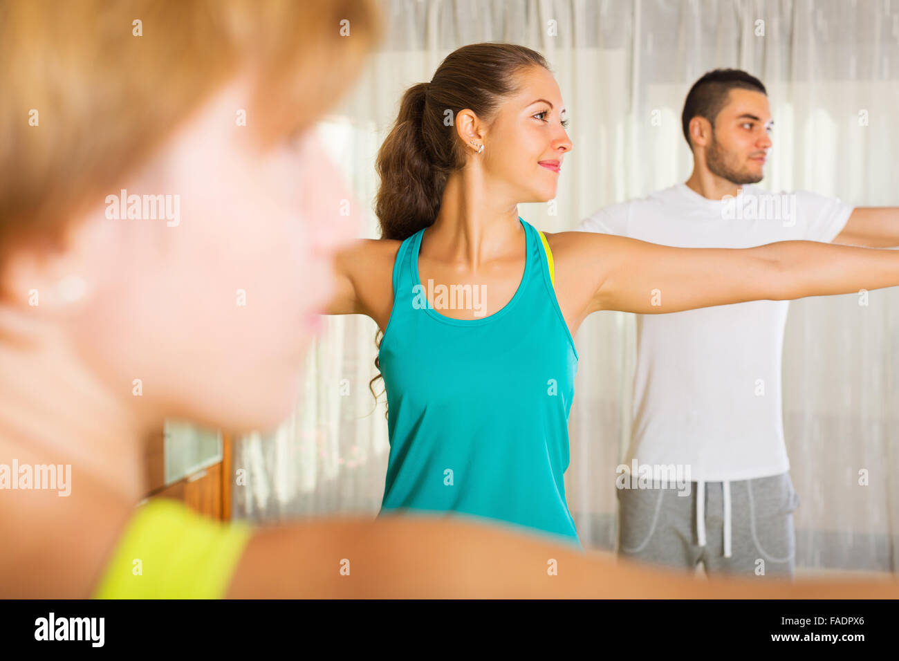 Adult smiling active people working in gym Stock Photo - Alamy