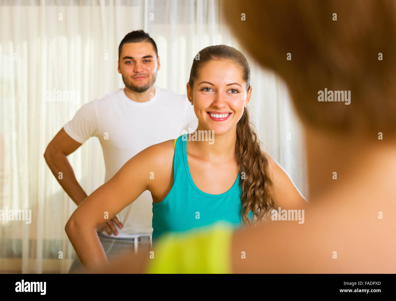 Smiling active people working in gym Stock Photo - Alamy