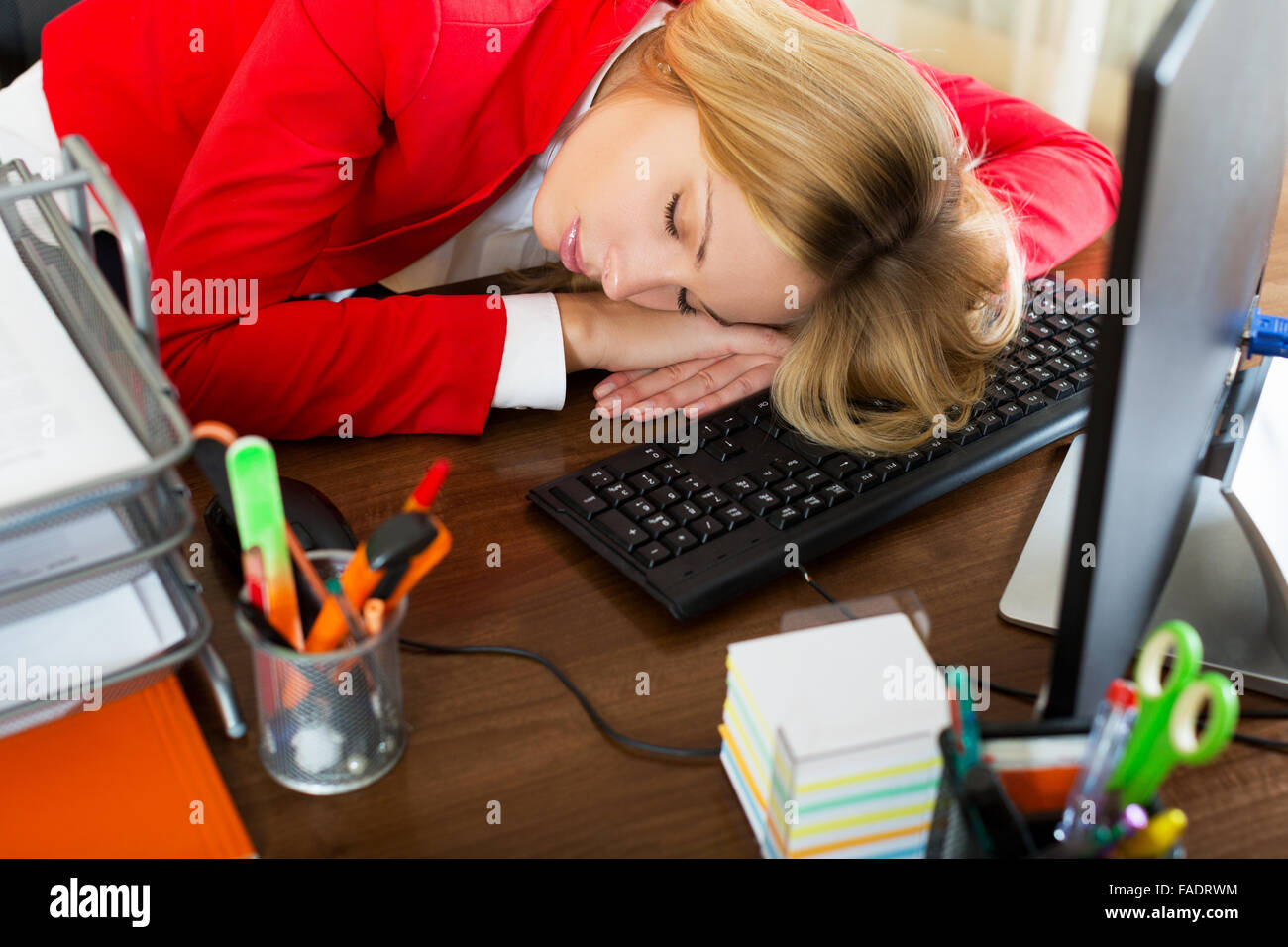 Tired girl sleeping at office desk Stock Photo - Alamy