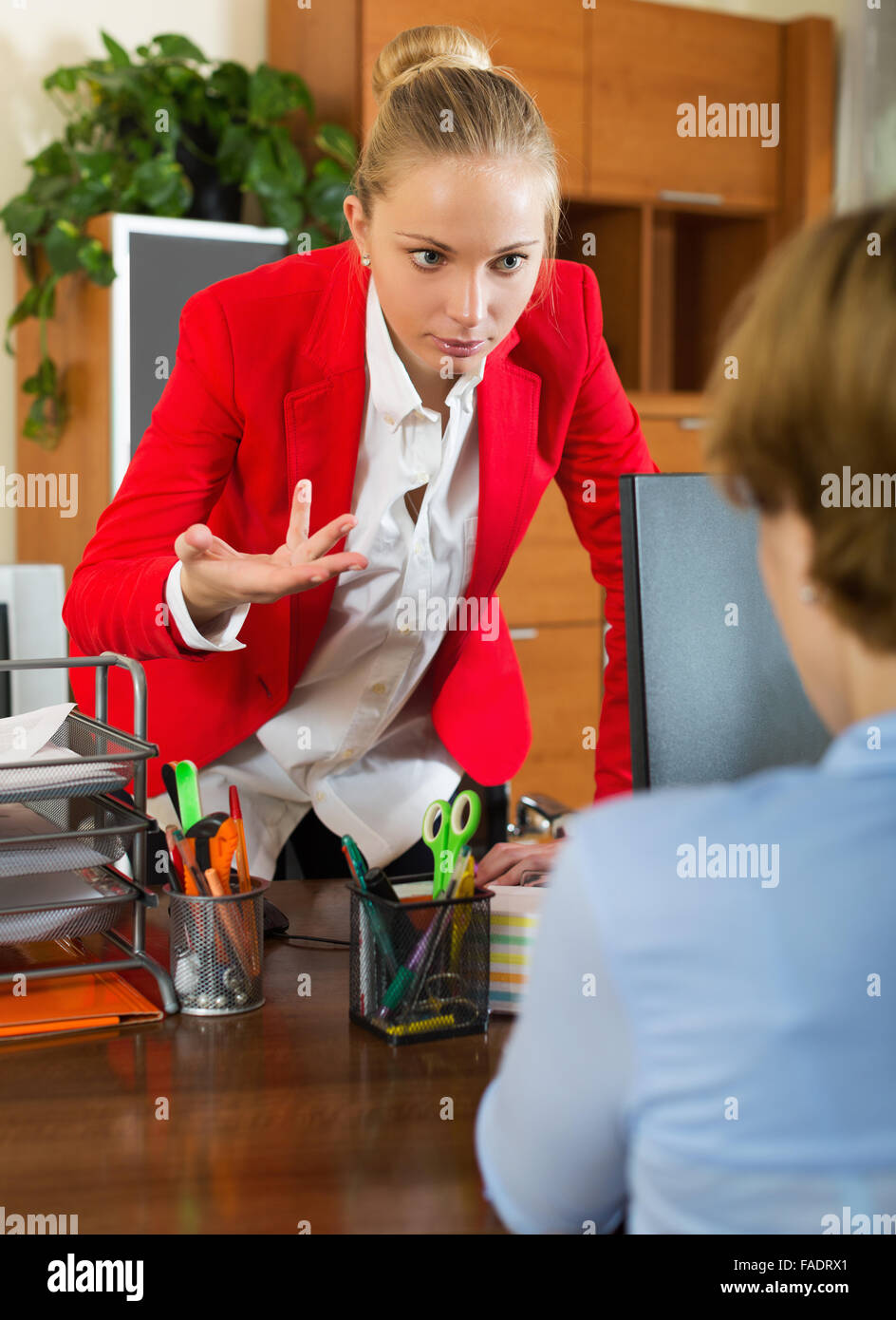 Nervous woman boss listening to excuses from clerk at office Stock ...