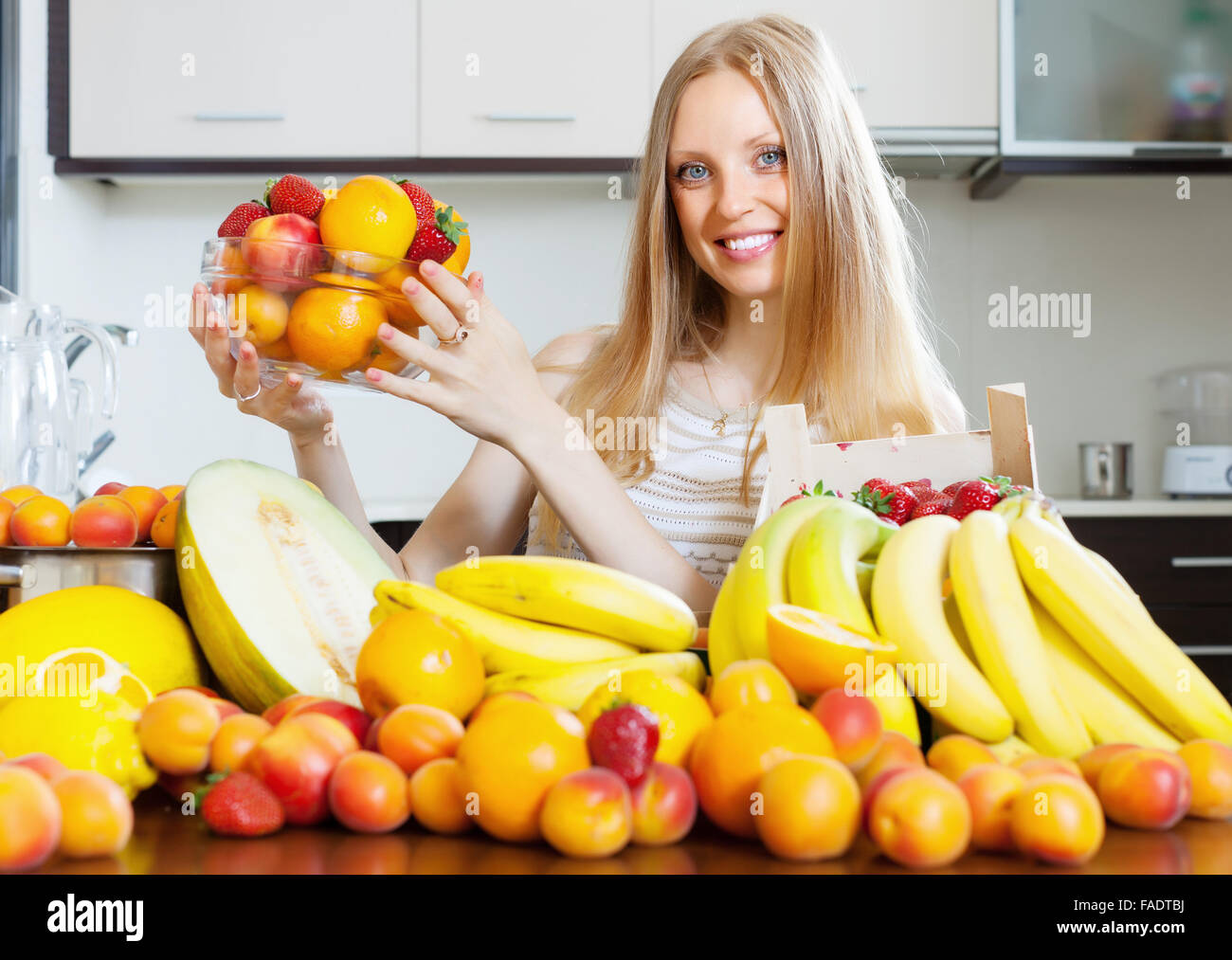 girl holding various fruits in home kitchen Stock Photo - Alamy