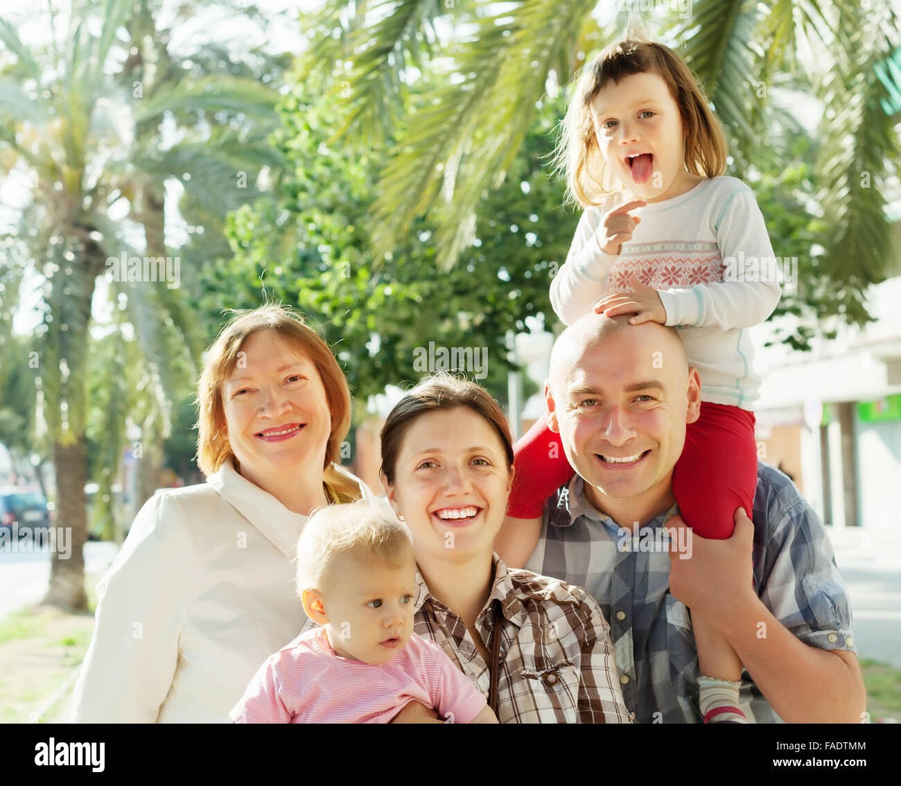 Happy three generations family in summer street Stock Photo - Alamy