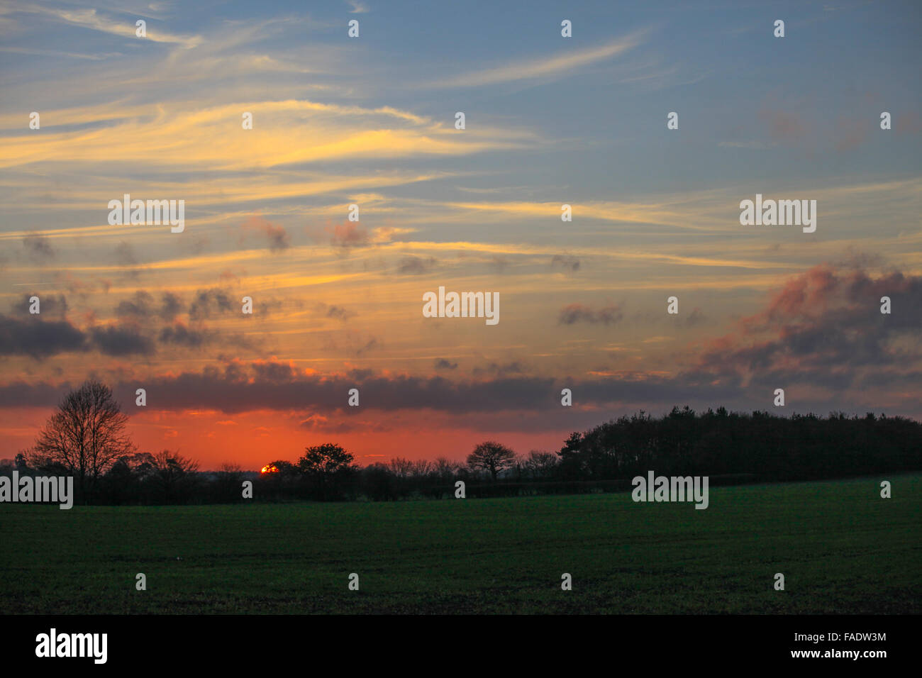 Clouds at sunset, almost a silhouette. Sun light breaking through the ...