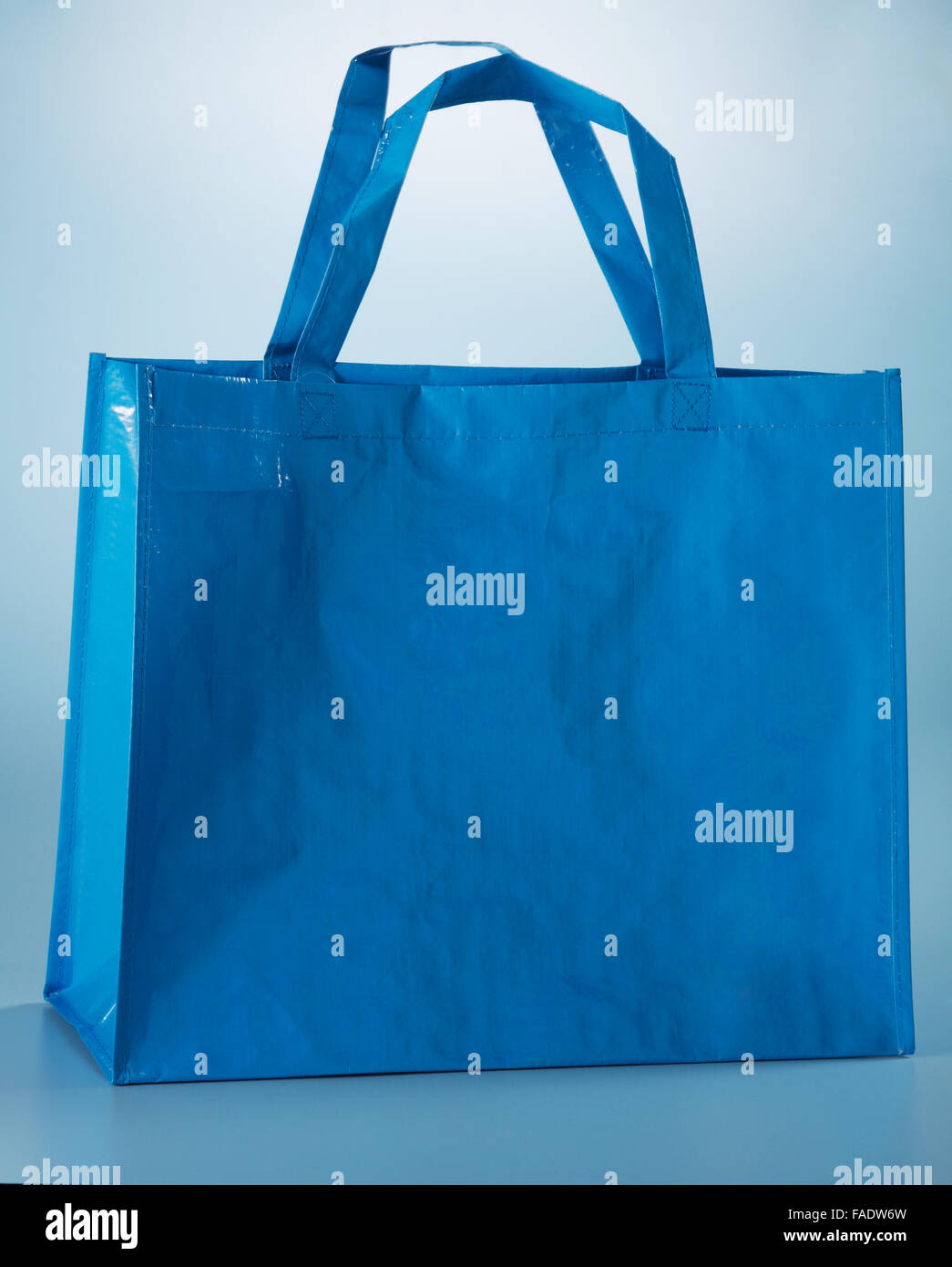Blue recycle bag on blue background Stock Photo - Alamy
