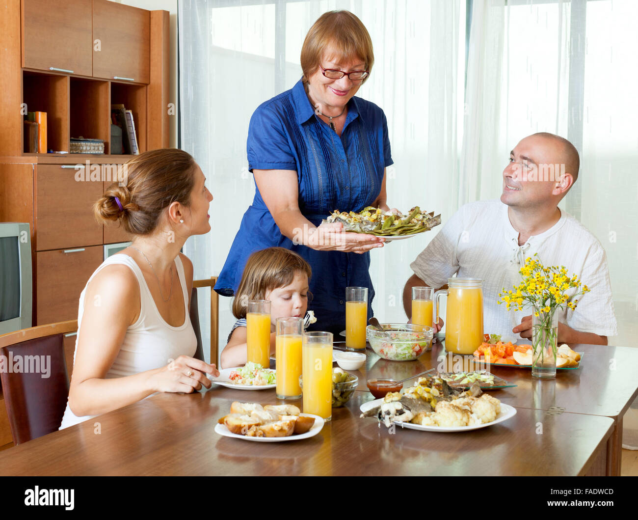 Happy family eating fish hi-res stock photography and images - Alamy