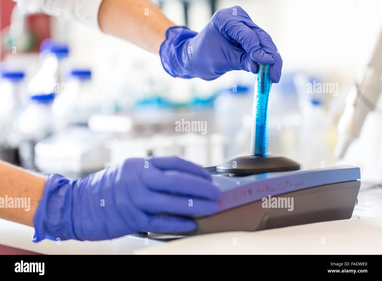 Hands of a female researcher doing research in a lab (shallow DOF ...