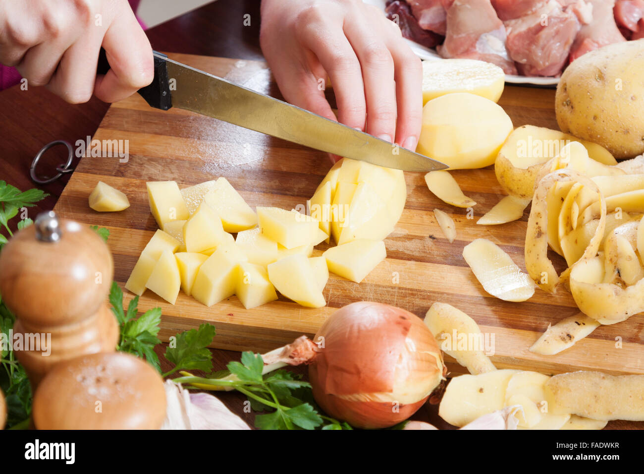 hands cutting potatoes at table in kitchen Stock Photo - Alamy
