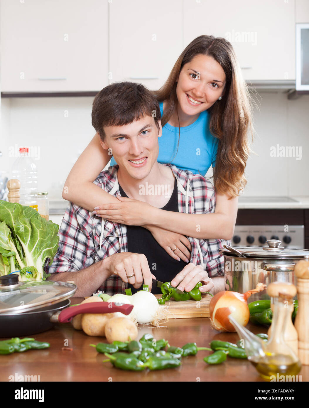Guy and pretty girl cooking in kitchen Stock Photo - Alamy