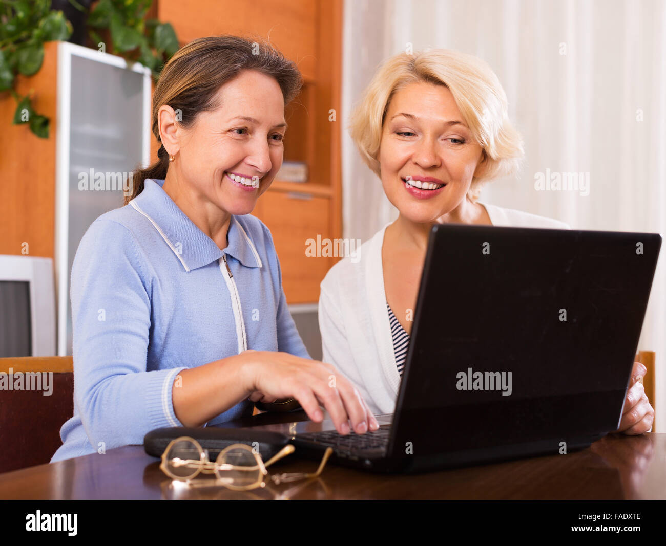 Happy seniore women browsering web at home and smiling. Focus on ...