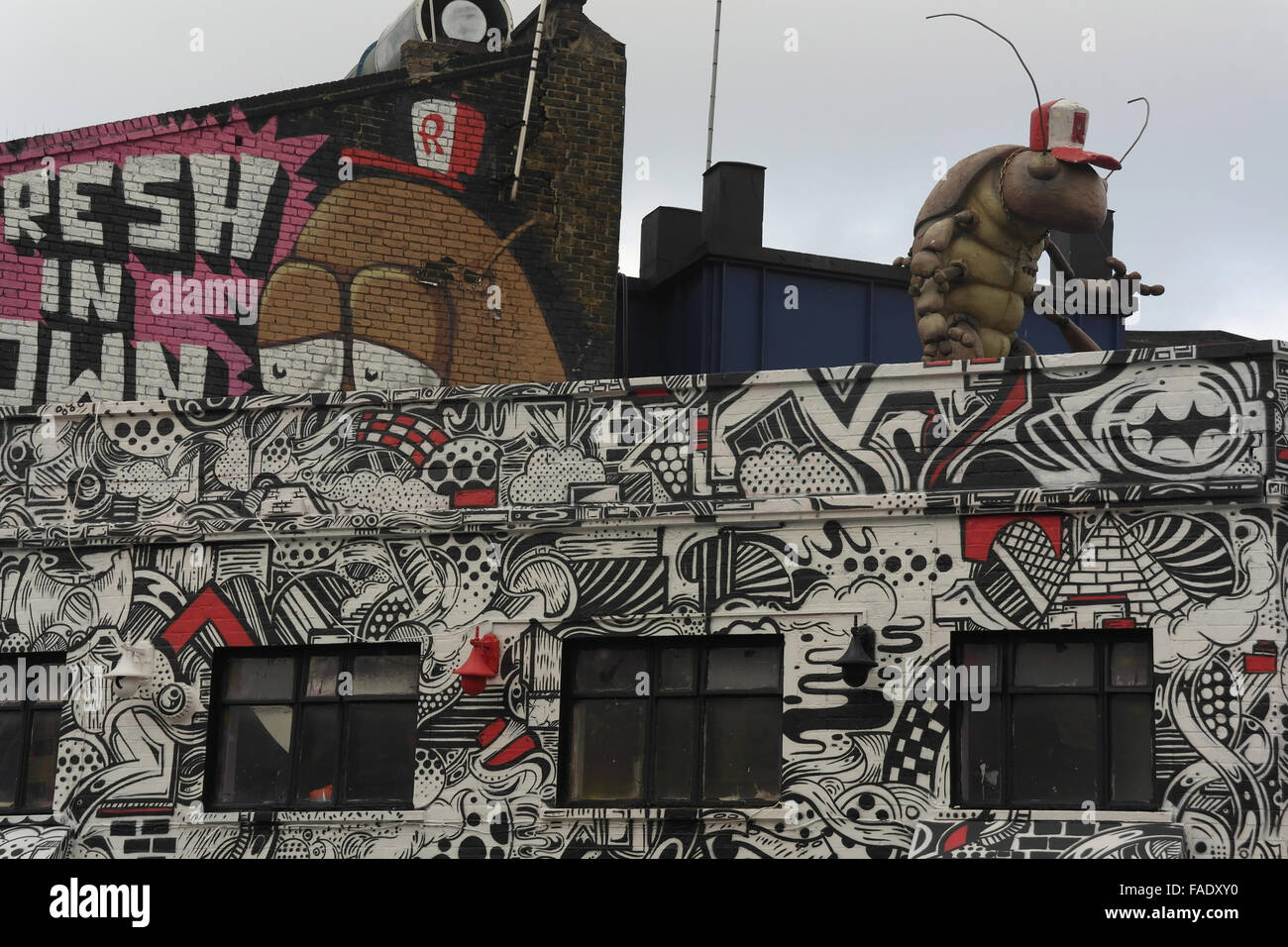 Close-up view Ronzo cockroach sculpture and 'Fresh in Town' mural above ...