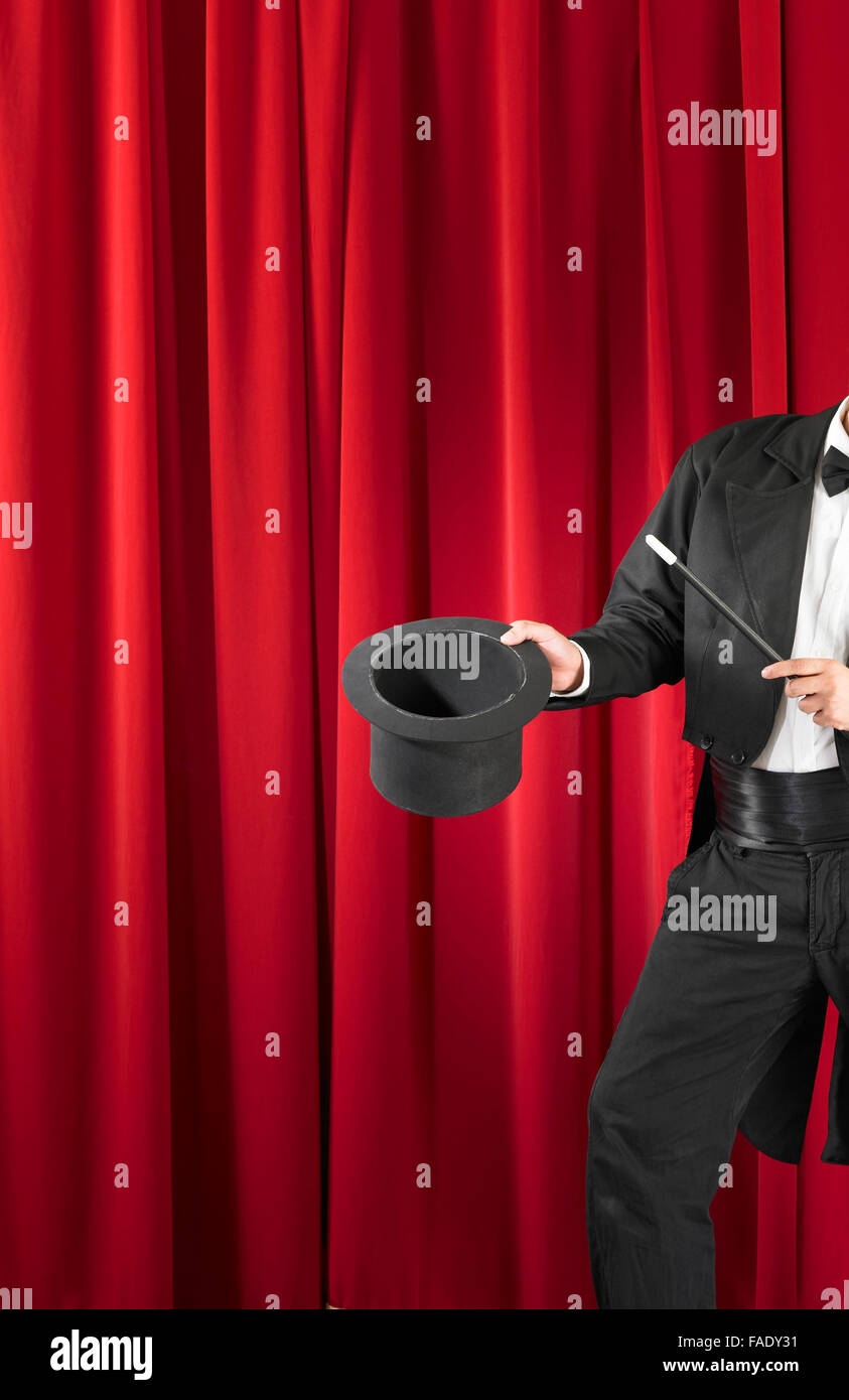 Magician Holding Magic Wand and Top Hat Stock Photo - Alamy