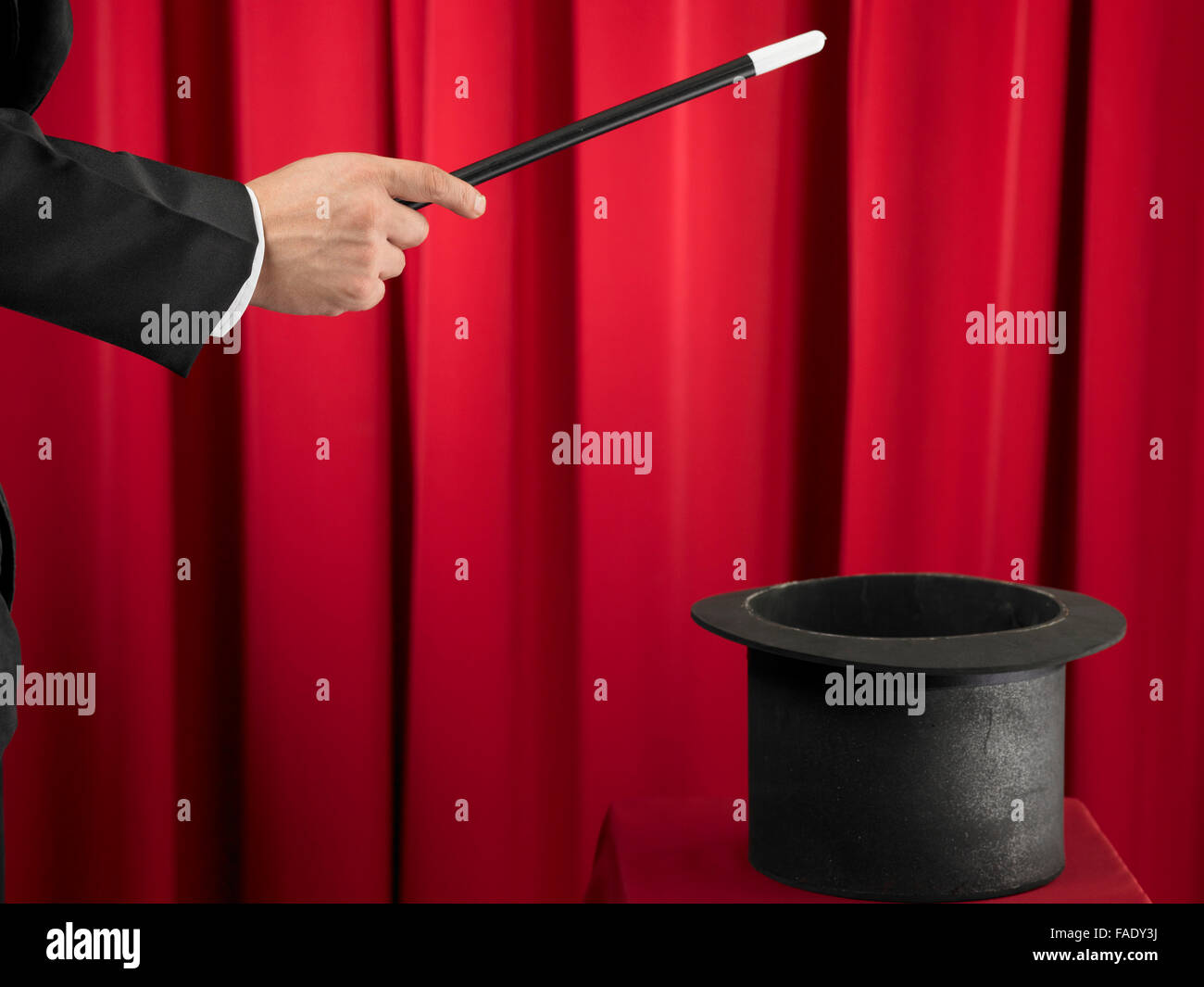 Magician Holding Magic Wand and Top Hat Stock Photo - Alamy