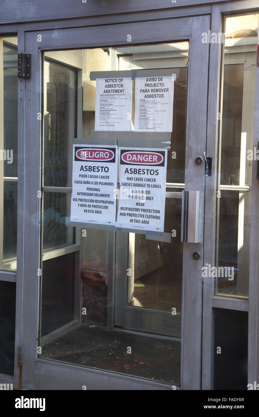 Posted warning signs of Asbestos in a building scheduled to be gutted ...
