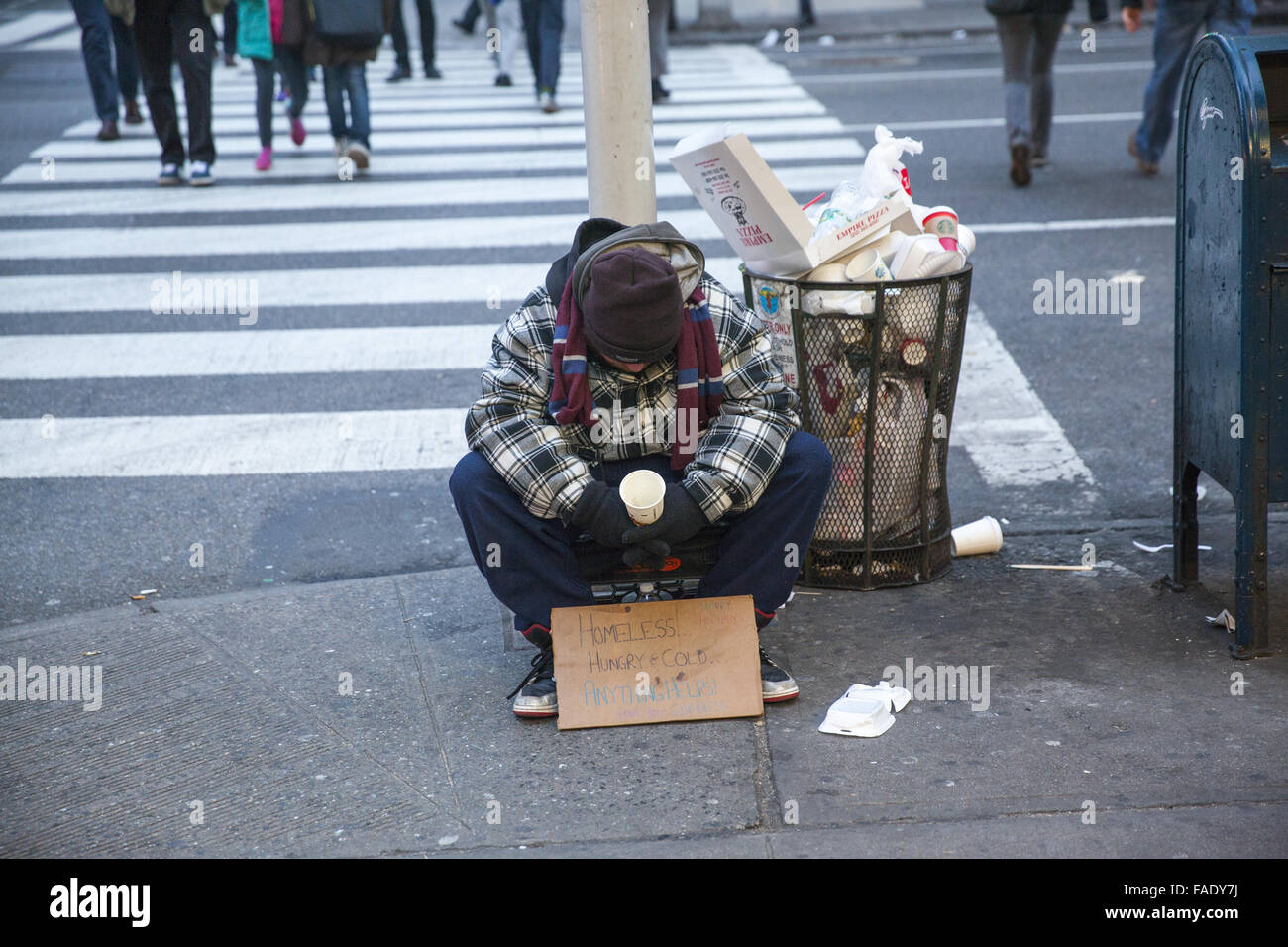 Tired homeless man begging on the street along 5th Avenue, New York ...