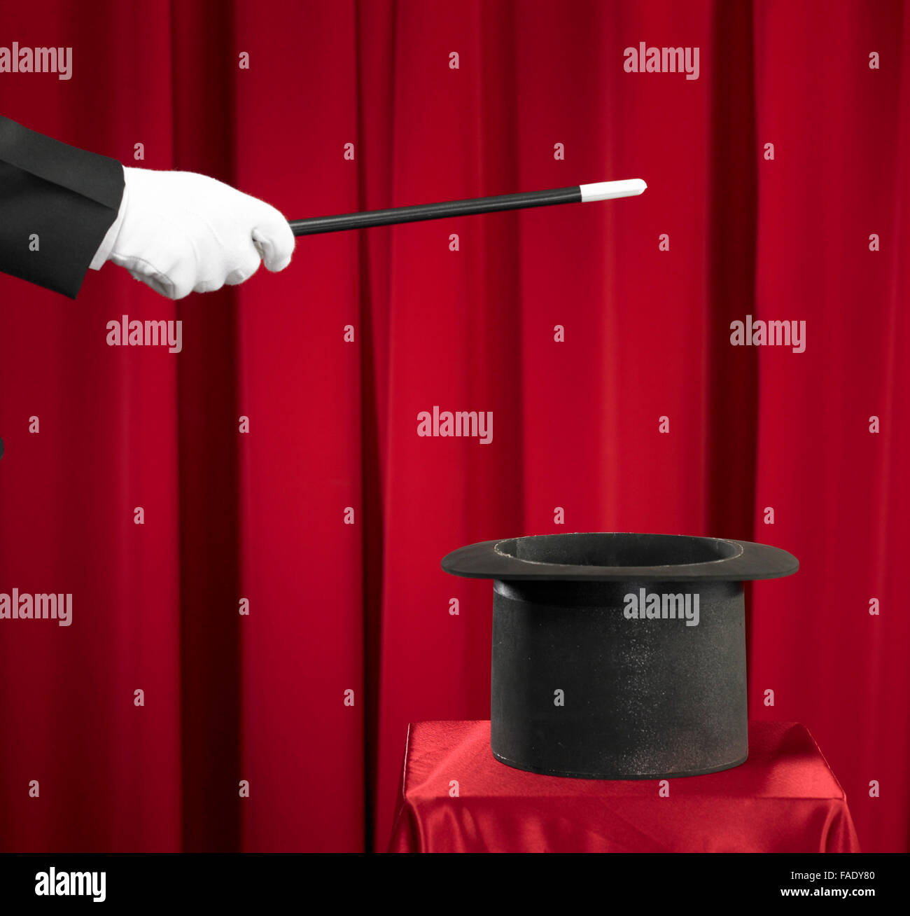 Magician Holding Magic Wand and Top Hat Stock Photo - Alamy