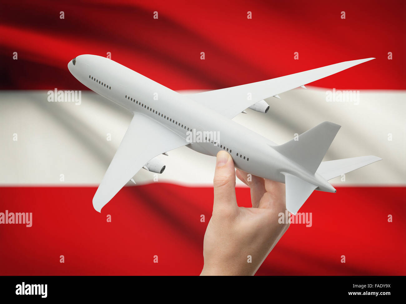 Airplane in hand with national flag on background - Austria Stock Photo ...