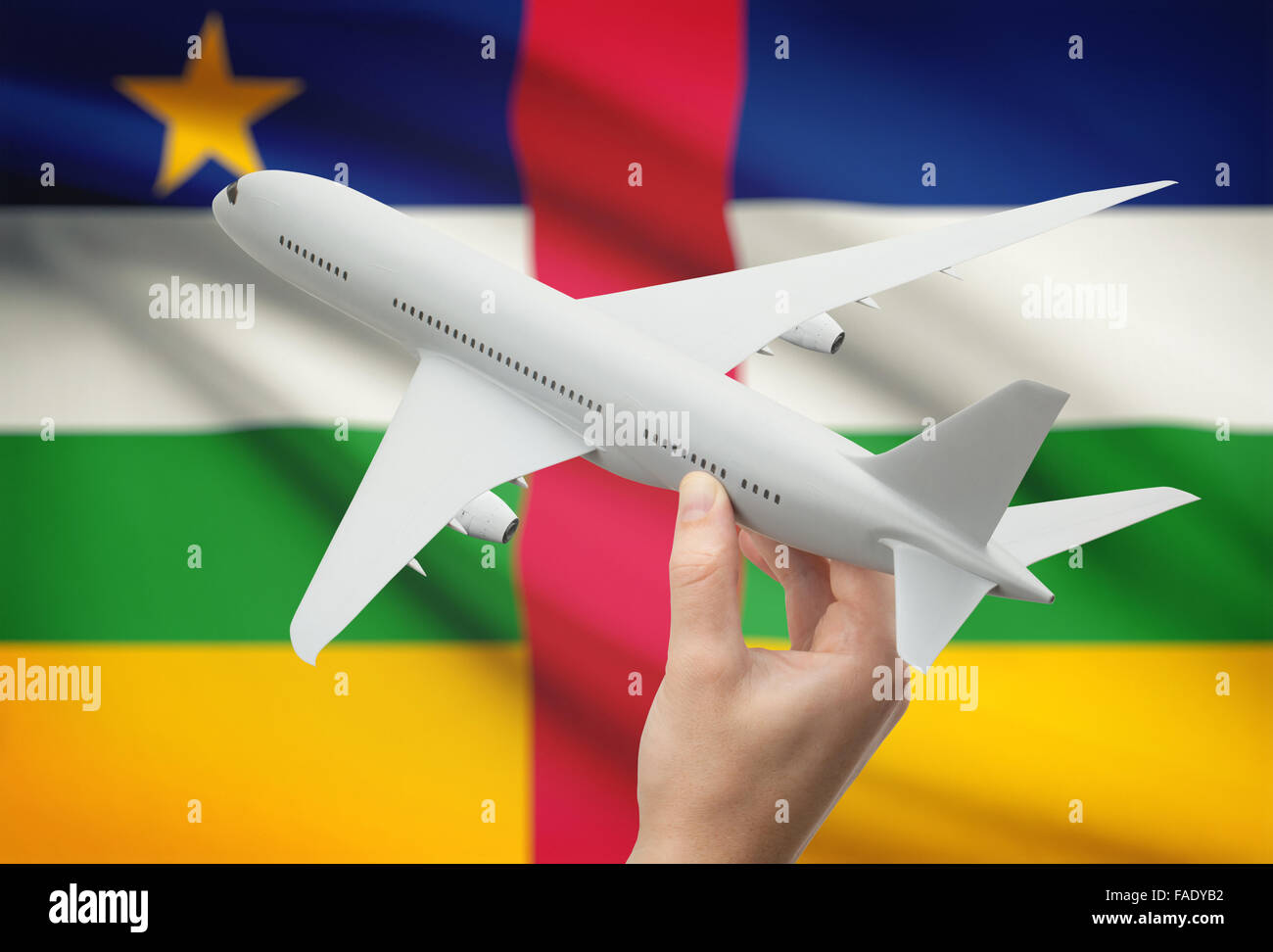 Airplane in hand with national flag on background - Central African ...