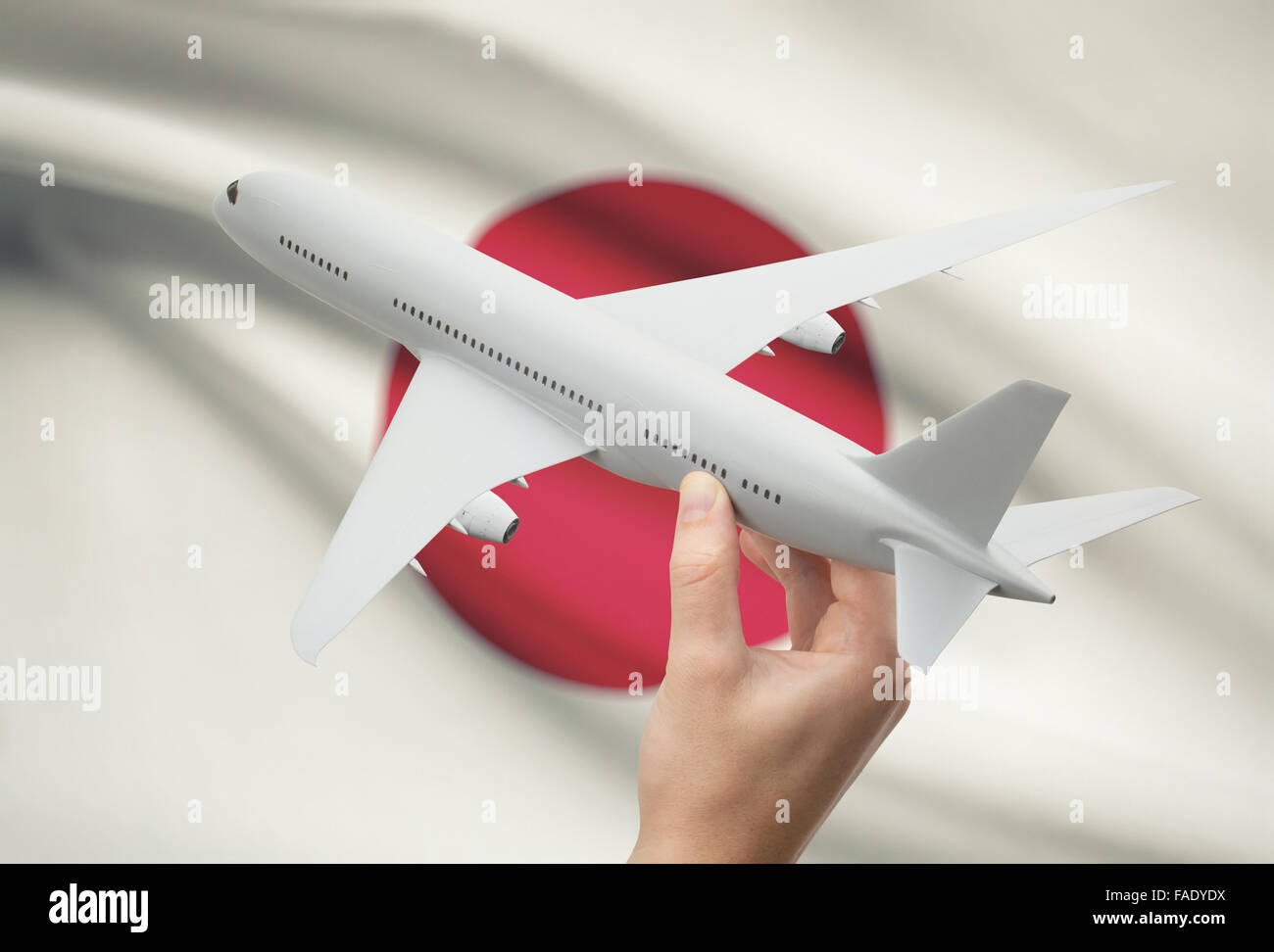 Airplane in hand with national flag on background - Japan Stock Photo ...