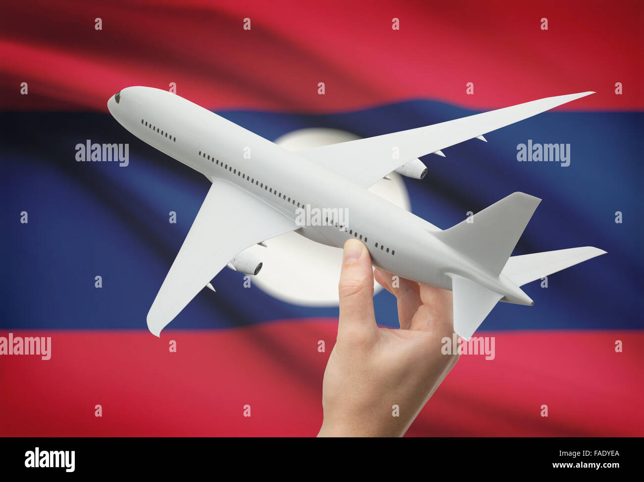 Airplane in hand with national flag on background - Laos Stock Photo ...